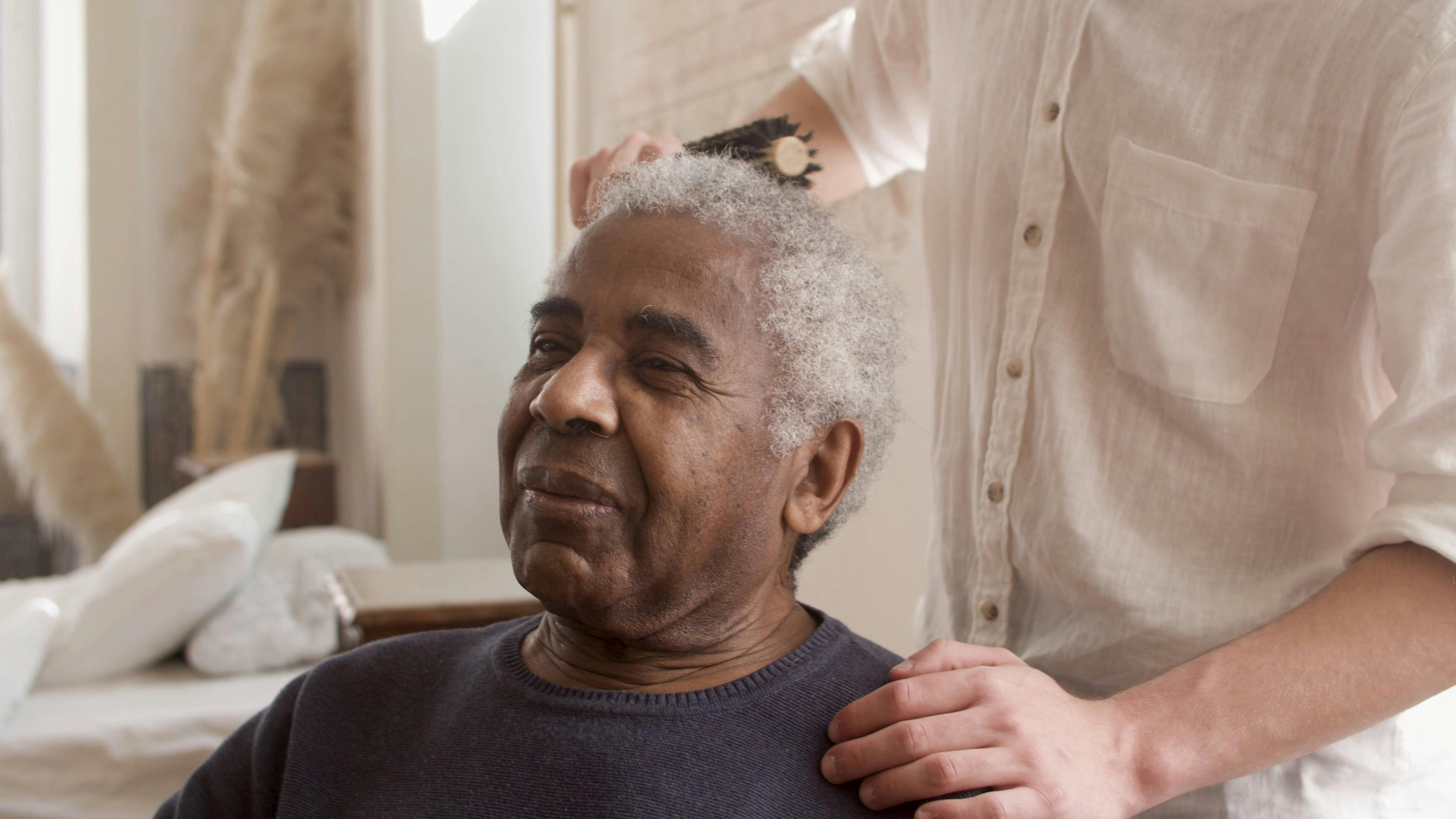 Faceless Man Combing an Enderly's hair · Free Stock Video