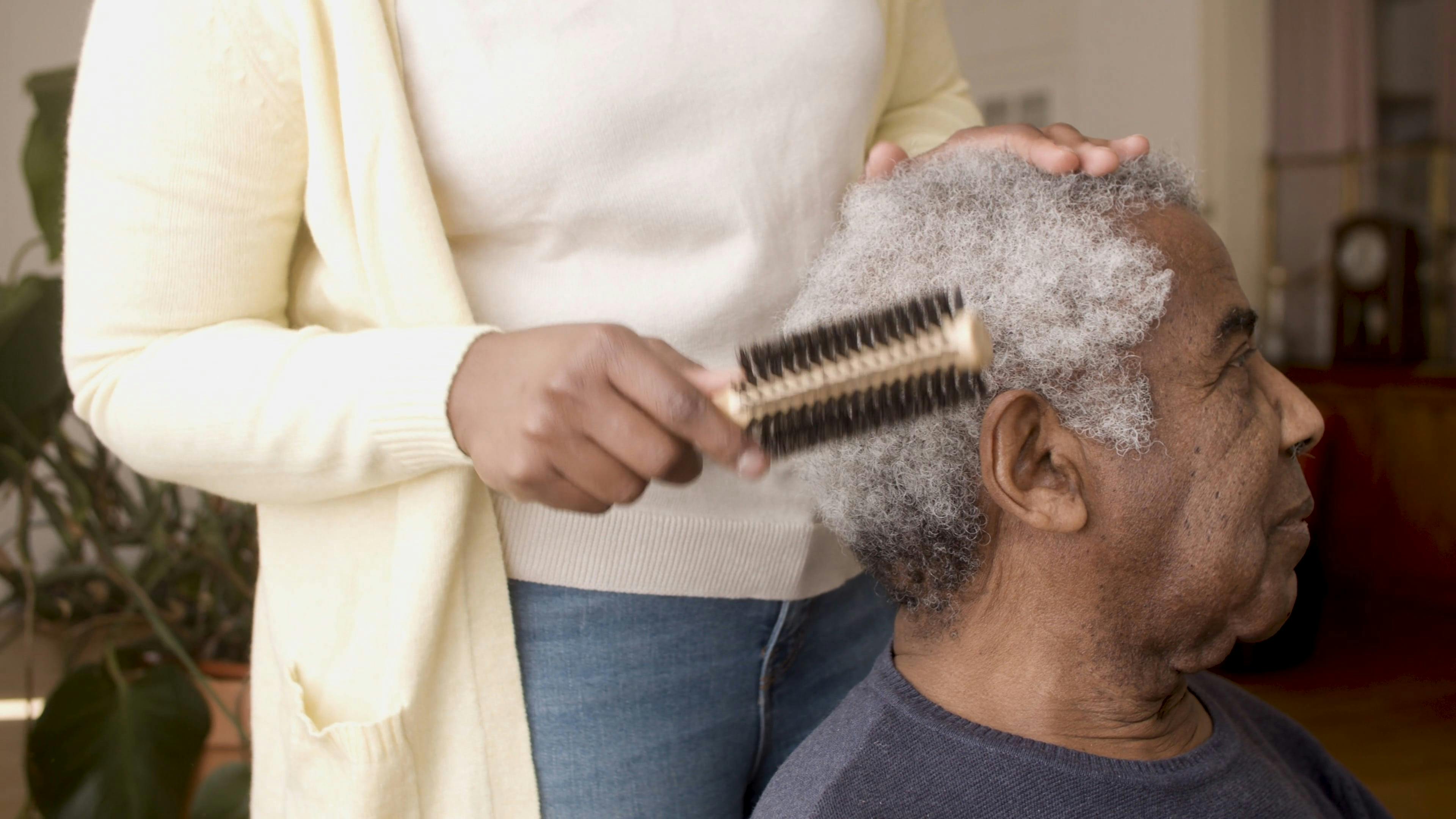 Faceless Woman Combing an Enderly's Hair · Free Stock Video