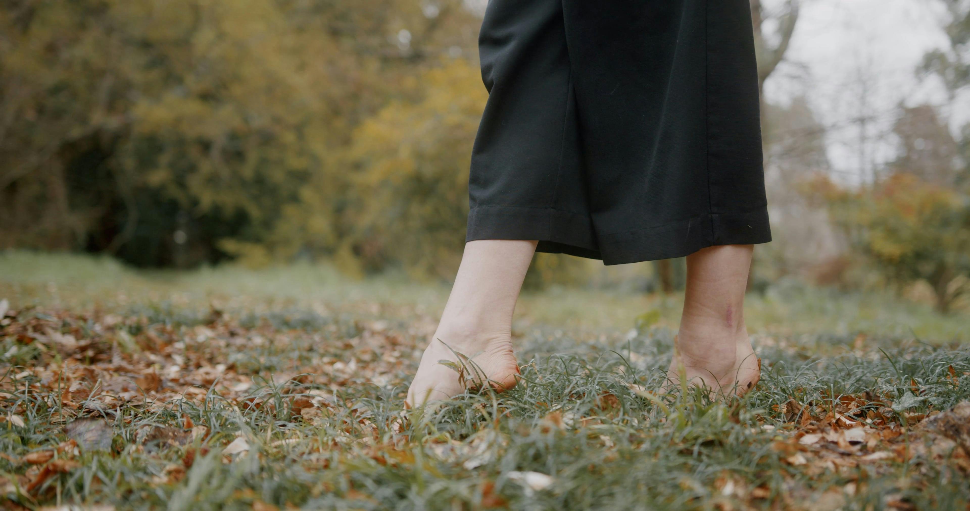 A Woman Standing on the Grass · Free Stock Video