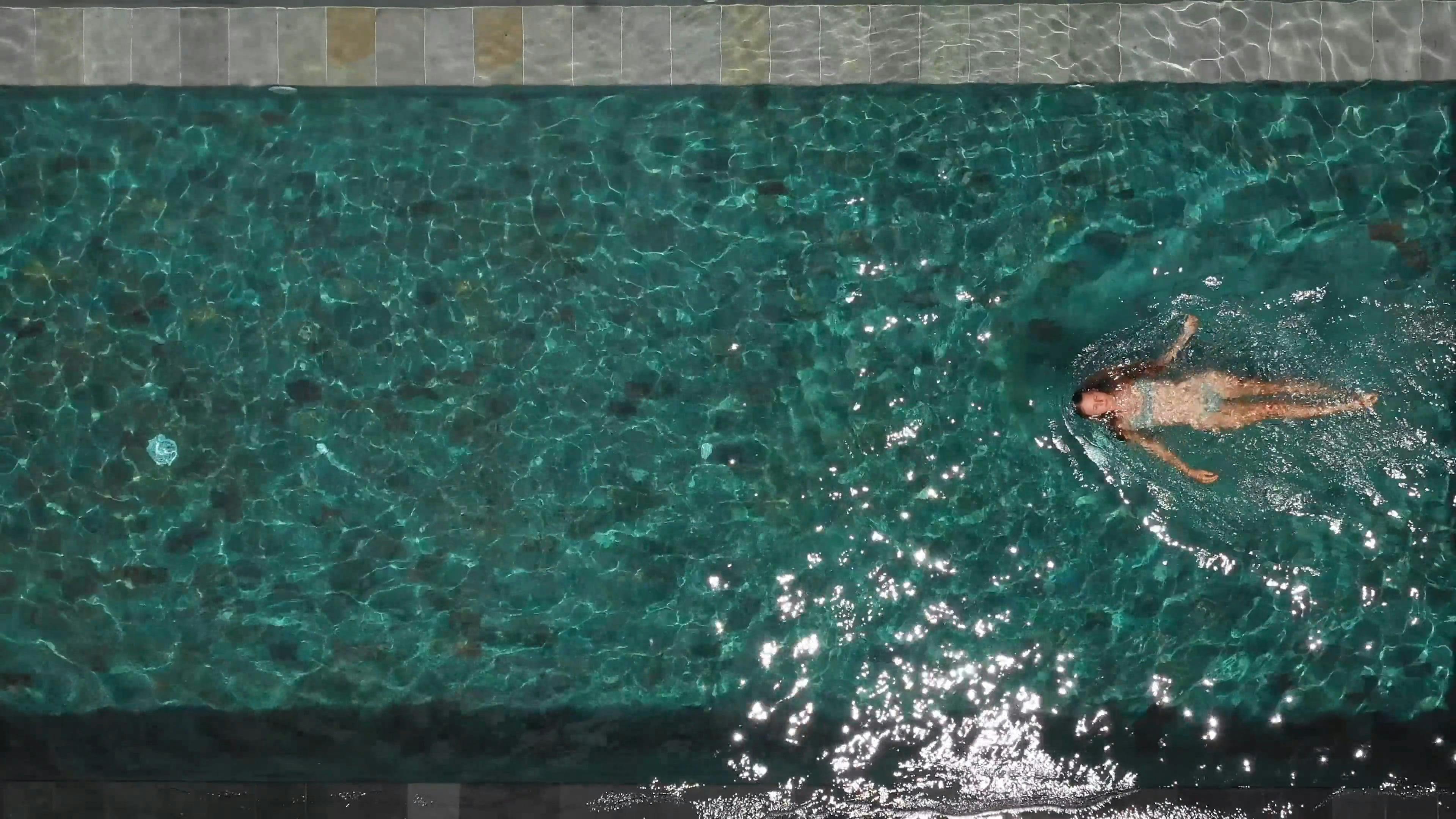 Drone Footage of A Woman Swimming on the Swimming Pool Free Stock Video ...