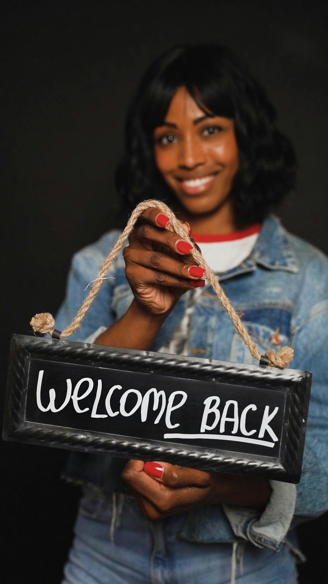 Woman Holding a Welcome Back Sign Free Stock Video Footage, Royalty ...