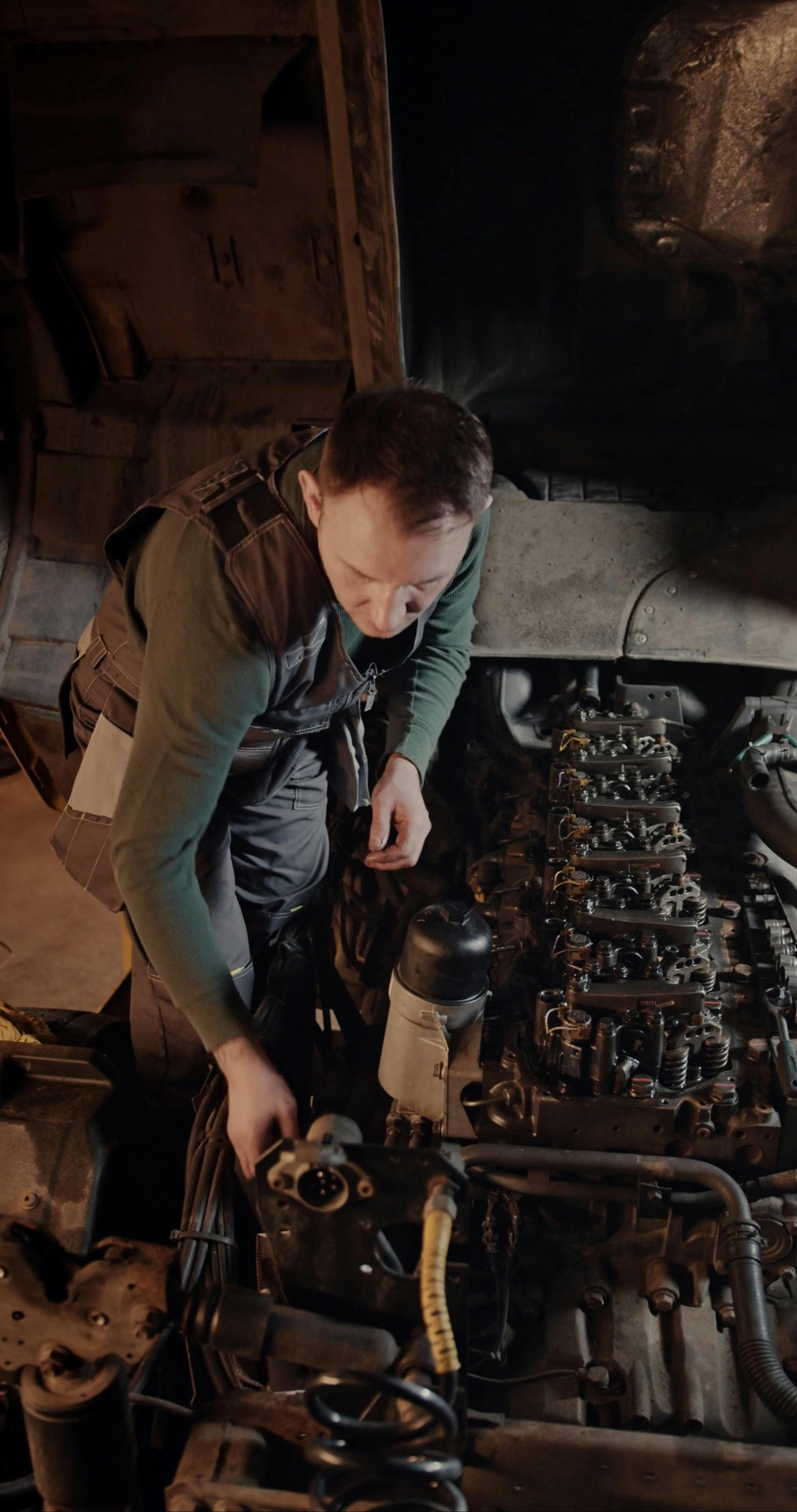 A Man Fixing an Engine · Free Stock Video