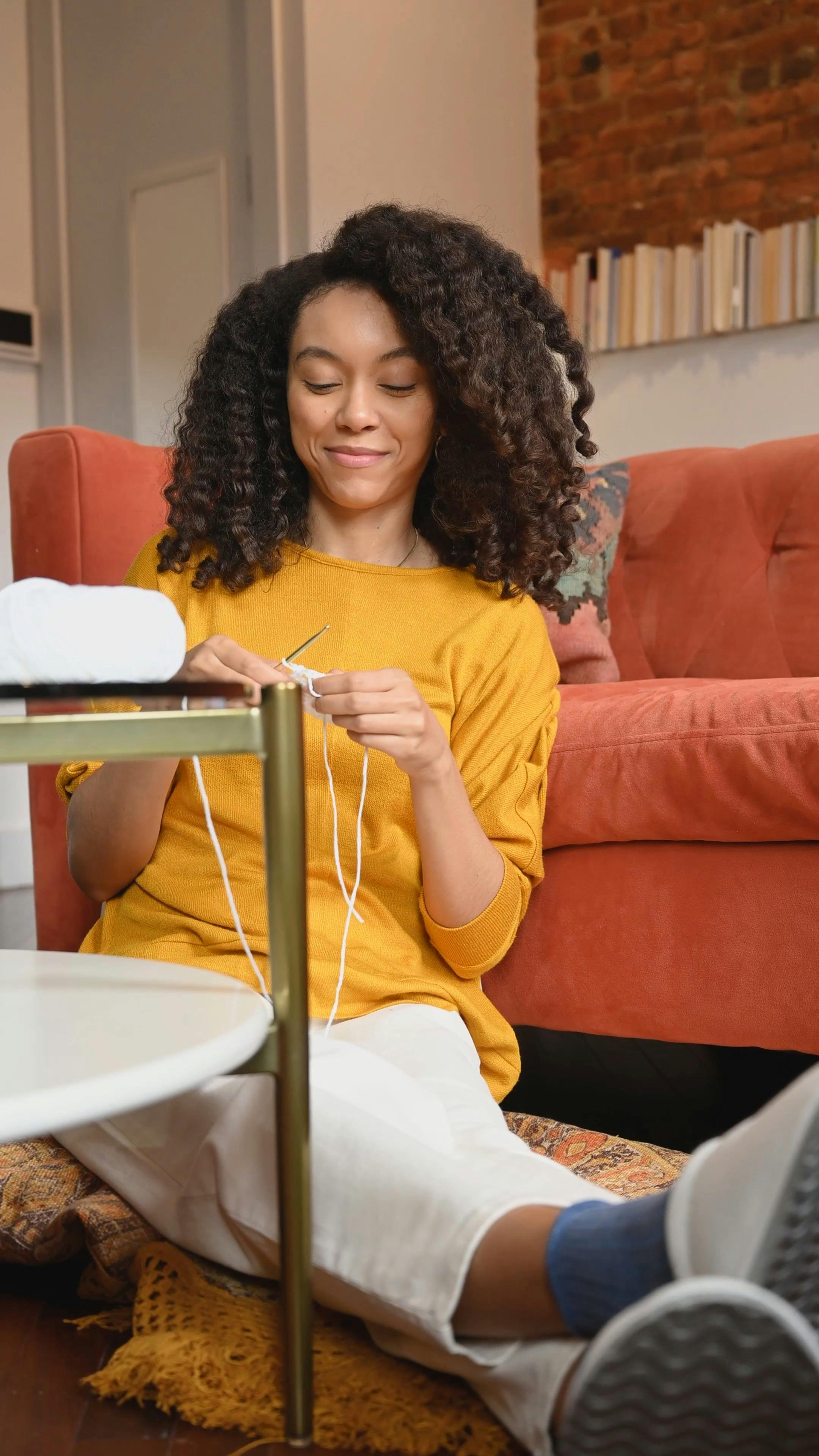 Young Woman Doing Crochet while Sitting on the Floor · Free Stock Video
