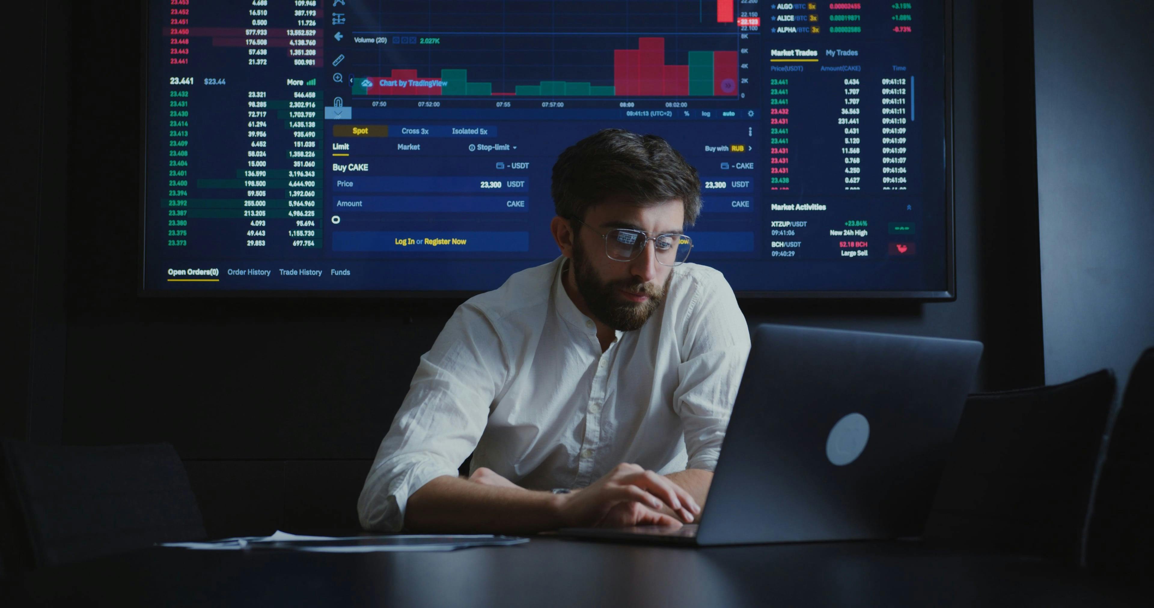 A Man Scrolling on His Laptop Behind a Big Screen · Free Stock Video
