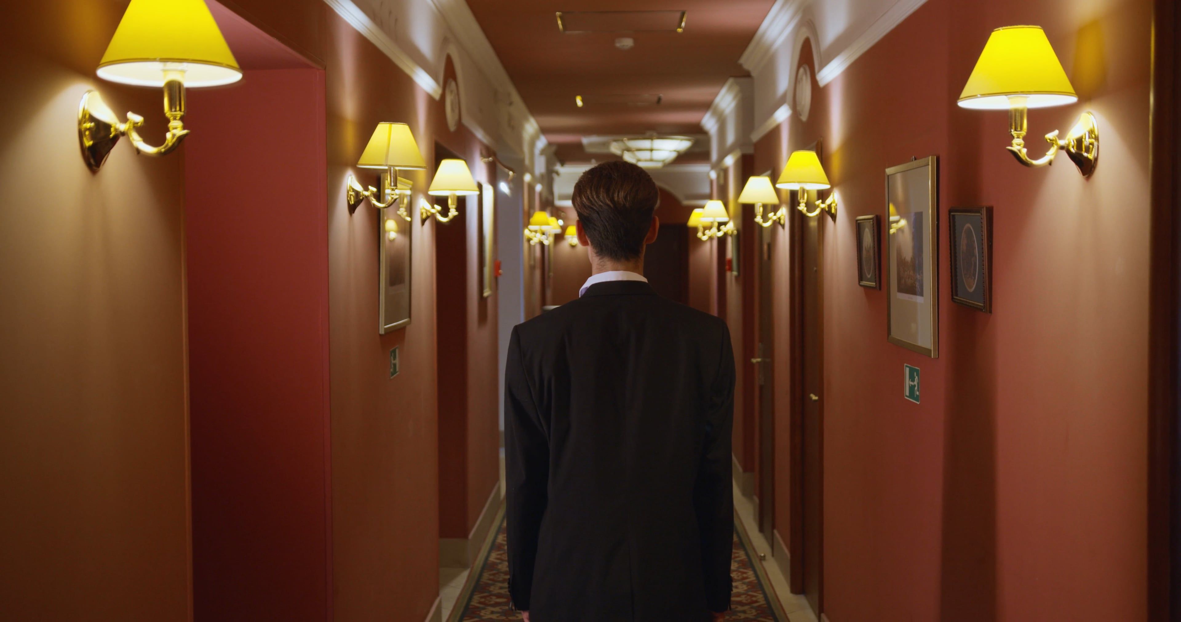 Man in Black Suit Standing in the Hallway · Free Stock Video