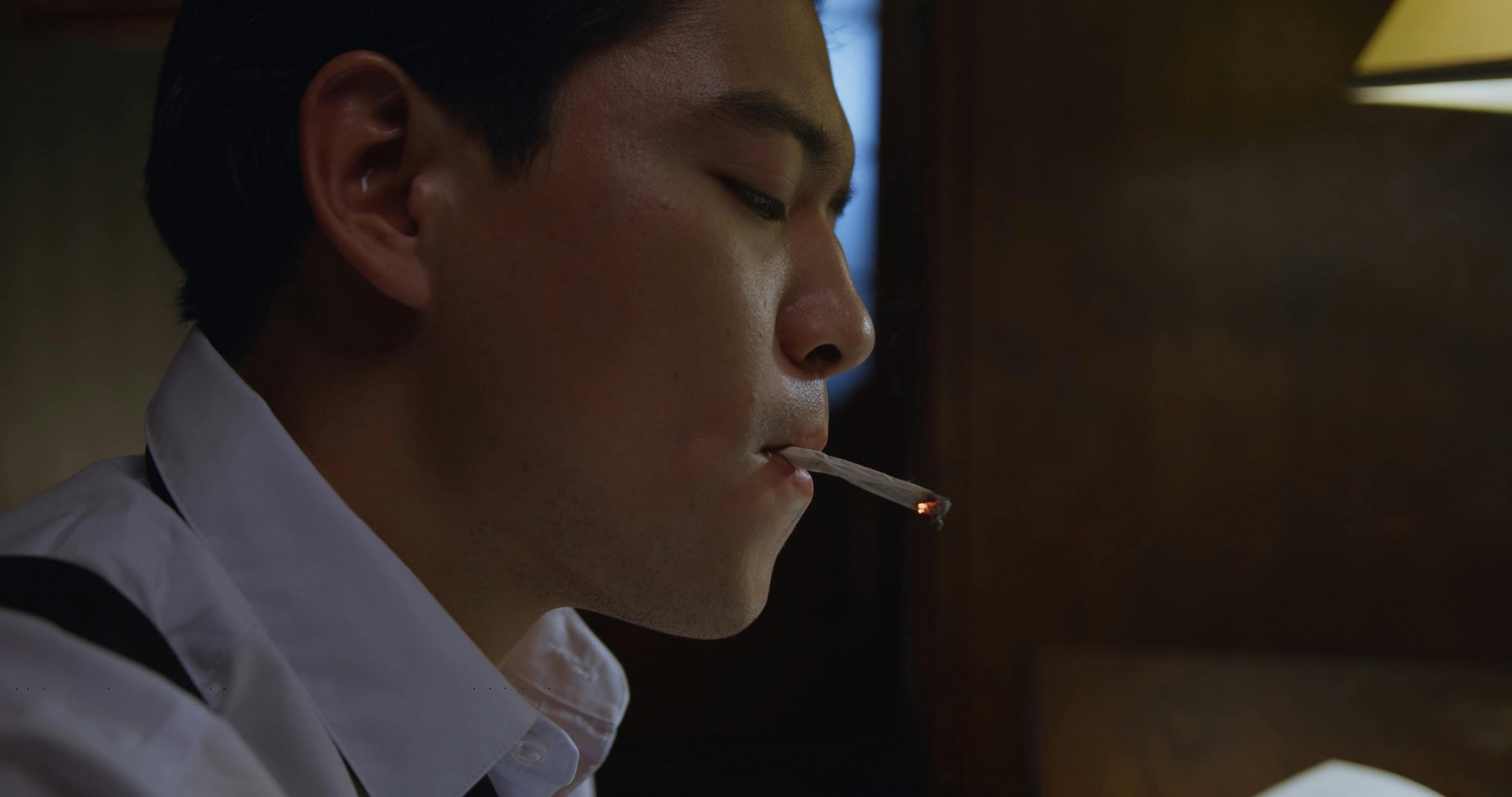 Man Smoking and Writing on White Paper · Free Stock Video