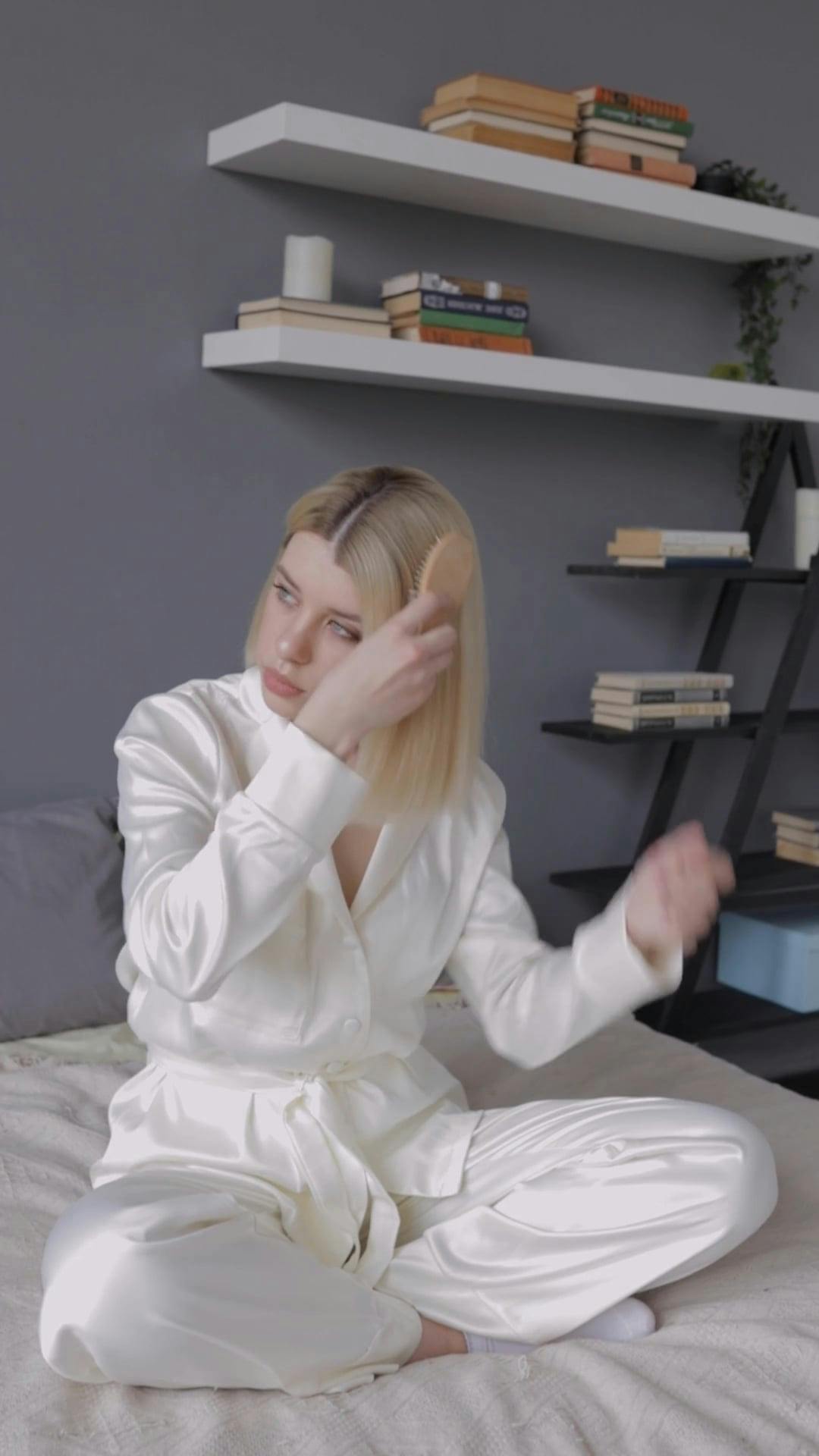 A Girl Getting Up from Bed while Tying Her Hair Free Stock Video ...