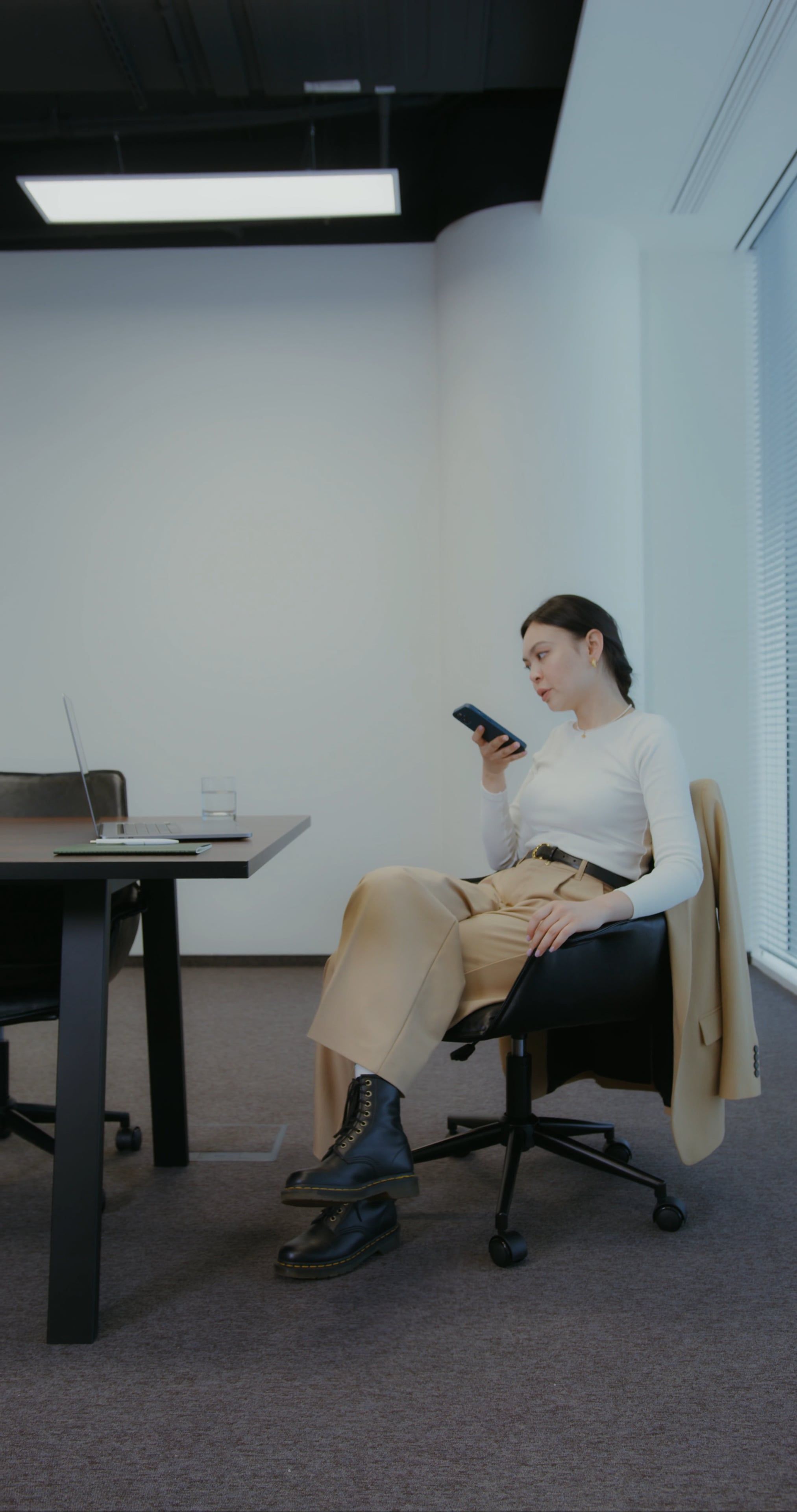 A Woman Texting while Sitting in an Office Chair Free Stock Video ...