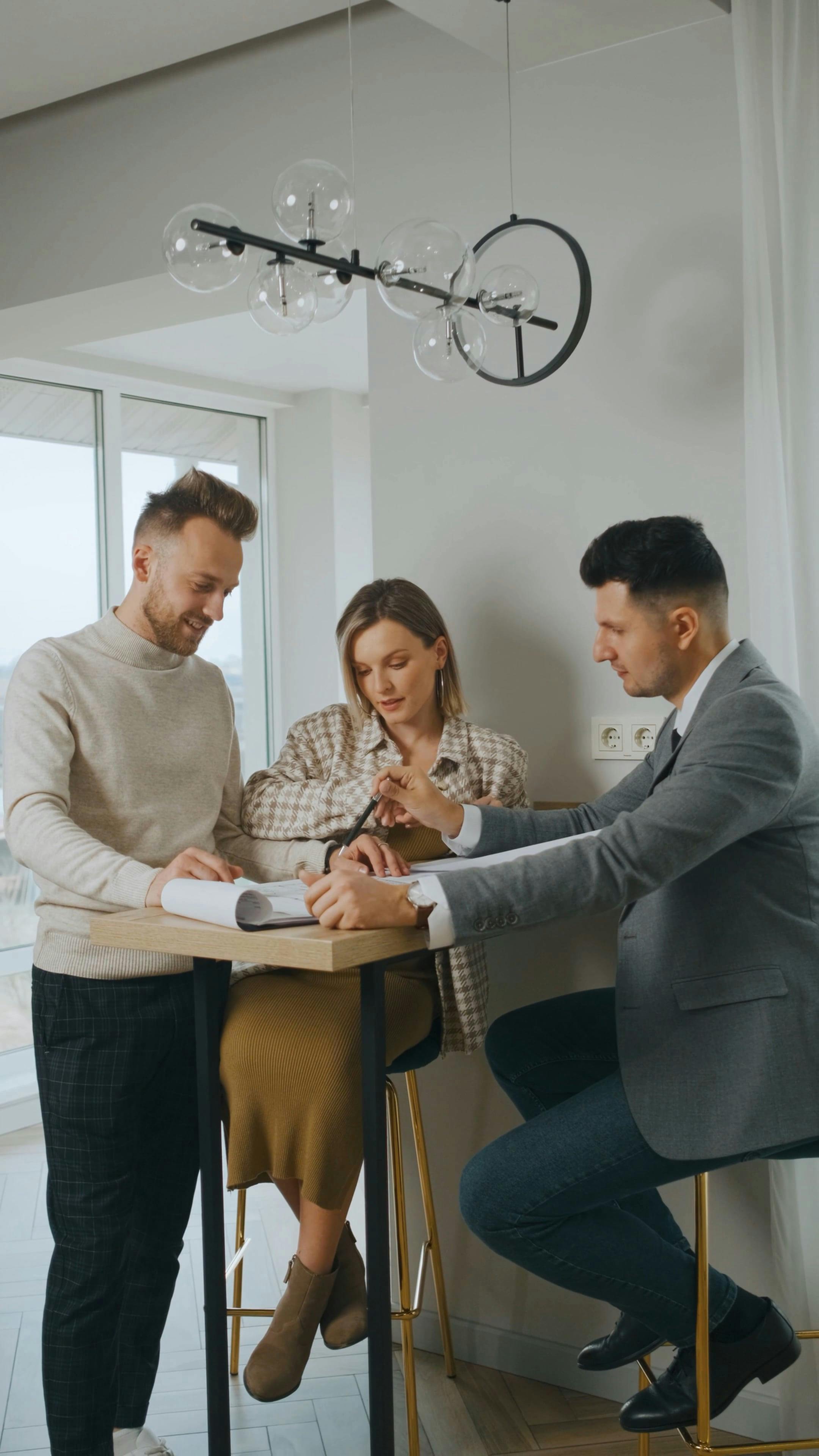 A Realtor Showing a House Floor Plan to a Couple Free Stock Video ...