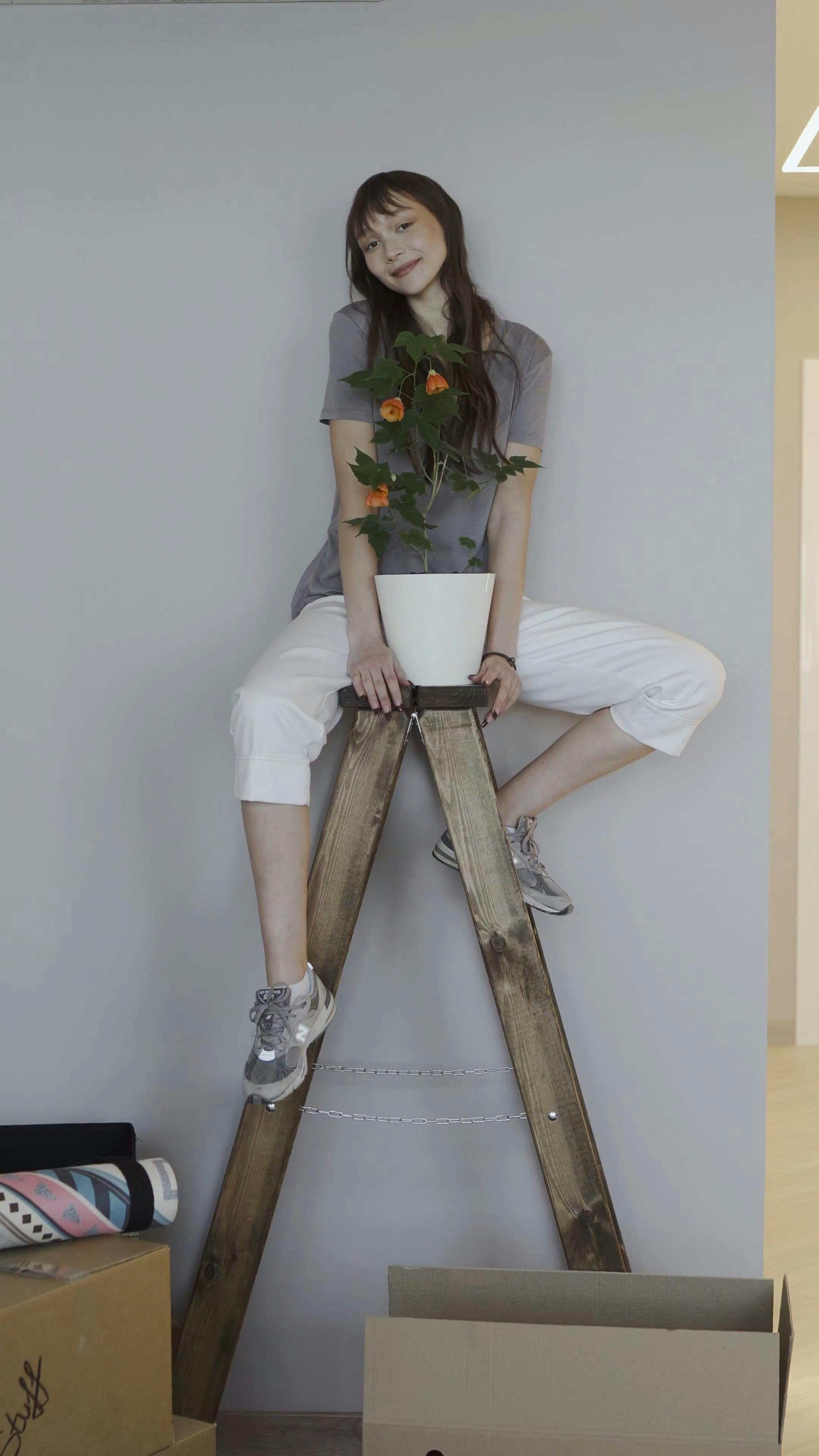 Woman Posing while Sitting on the Ladder · Free Stock Video