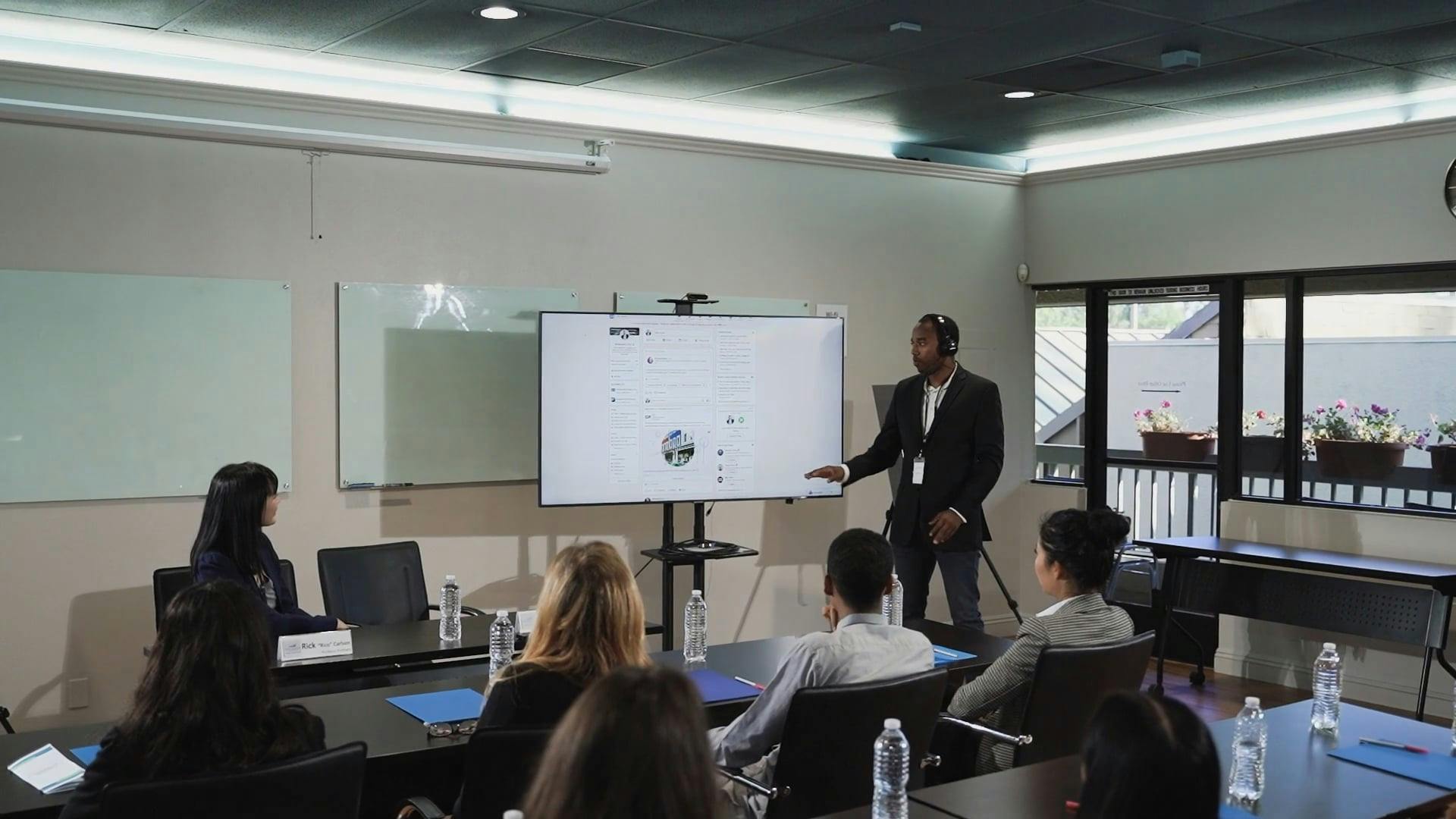 A Man Presenting in Front of People · Free Stock Video