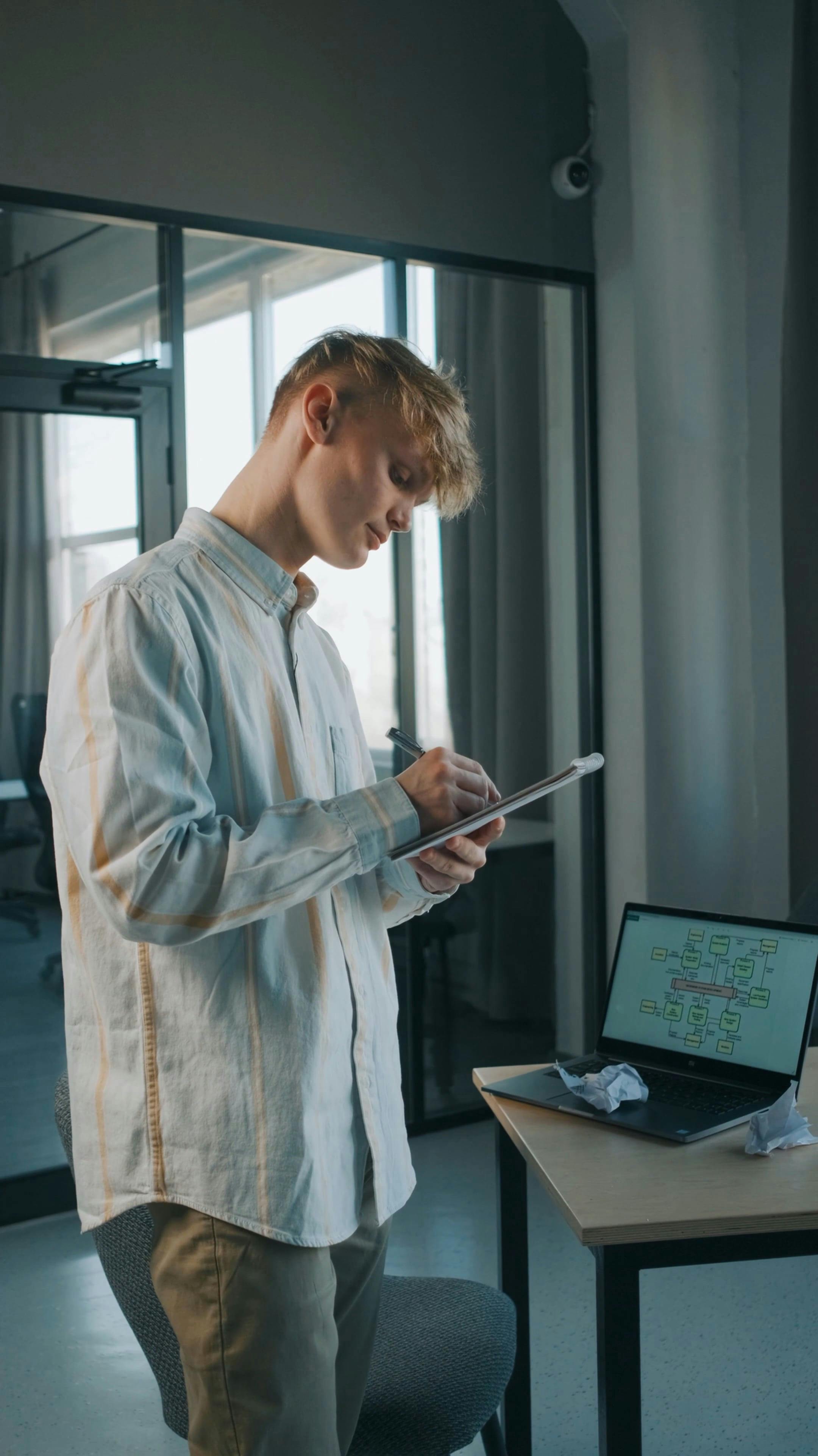 Man Standing while Writing on Paper · Free Stock Video