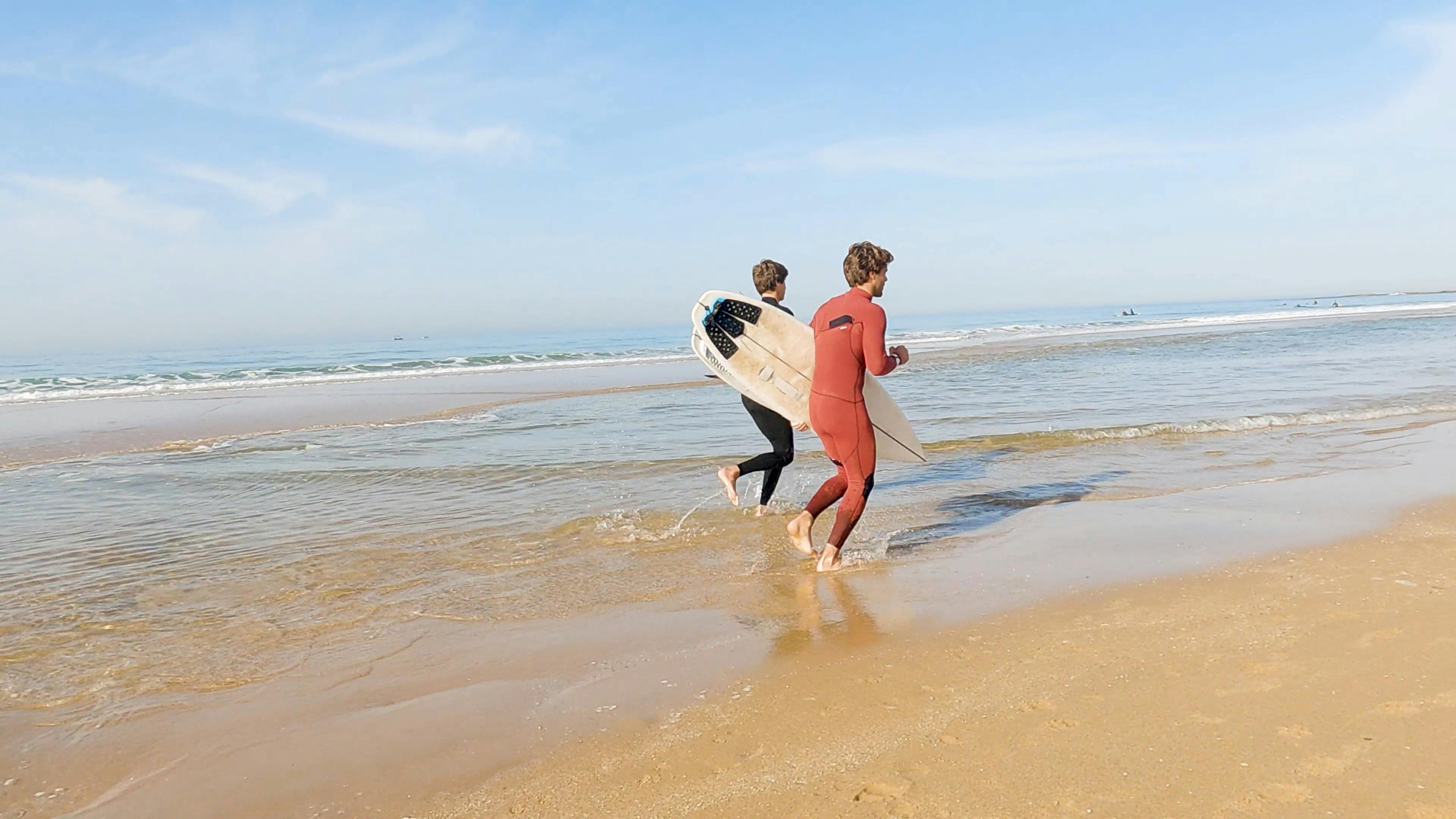 Surfers Running at the Shore while Holding their Surfboards · Free ...