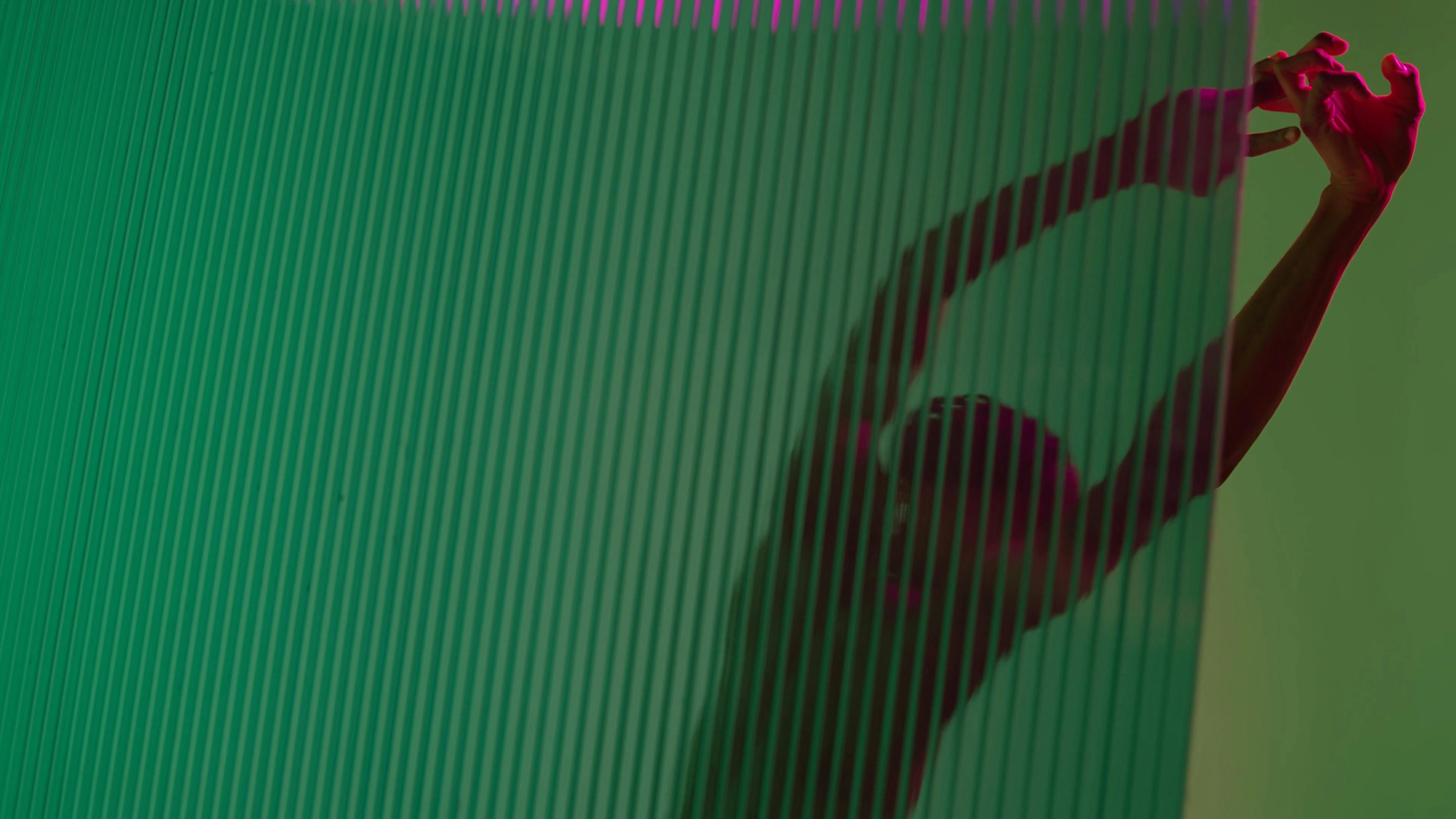 Back View of a Man Dancing Behind a Glass Wall · Free Stock Video