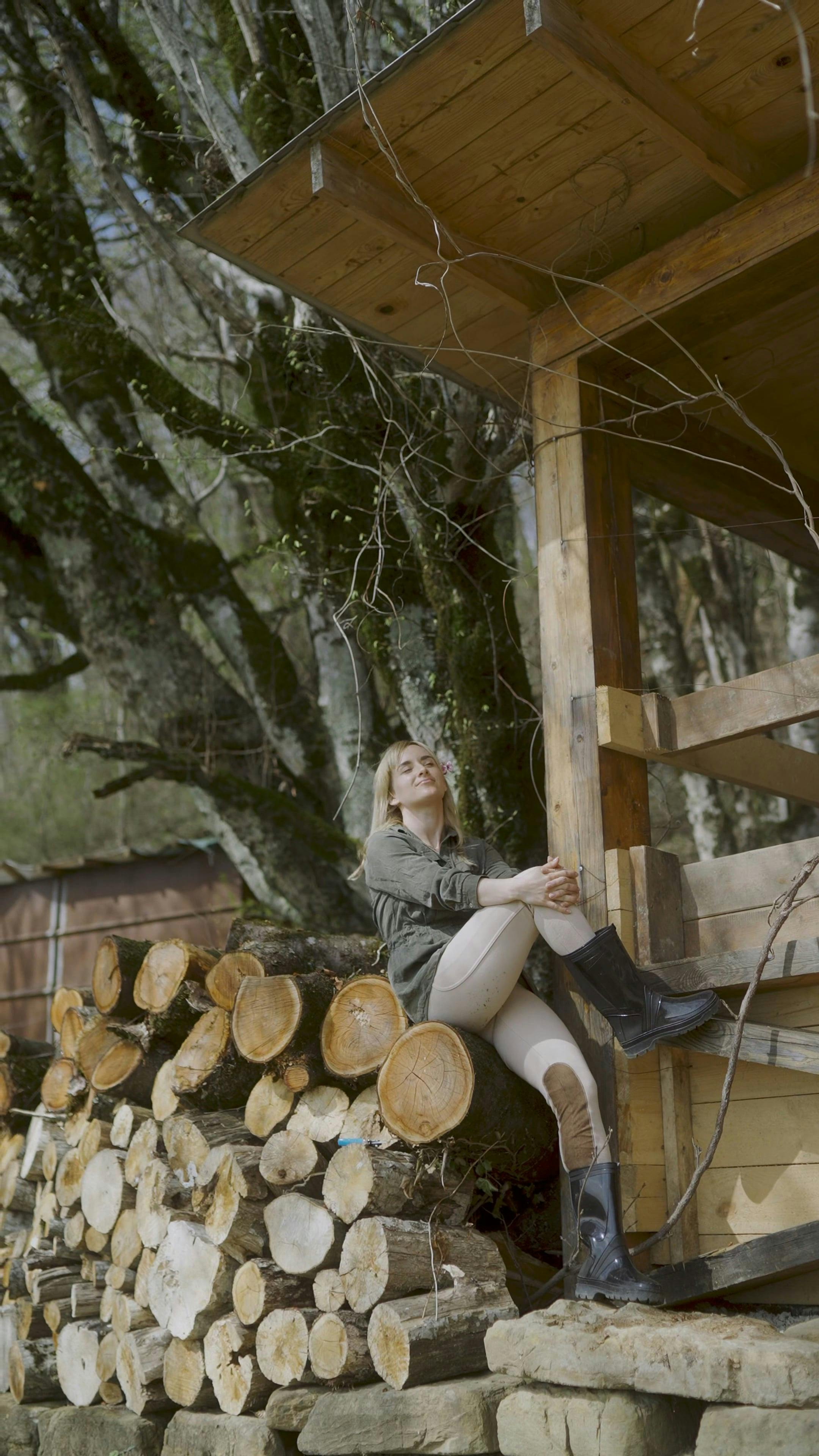 Woman Sitting On Tree Logs · Free Stock Video