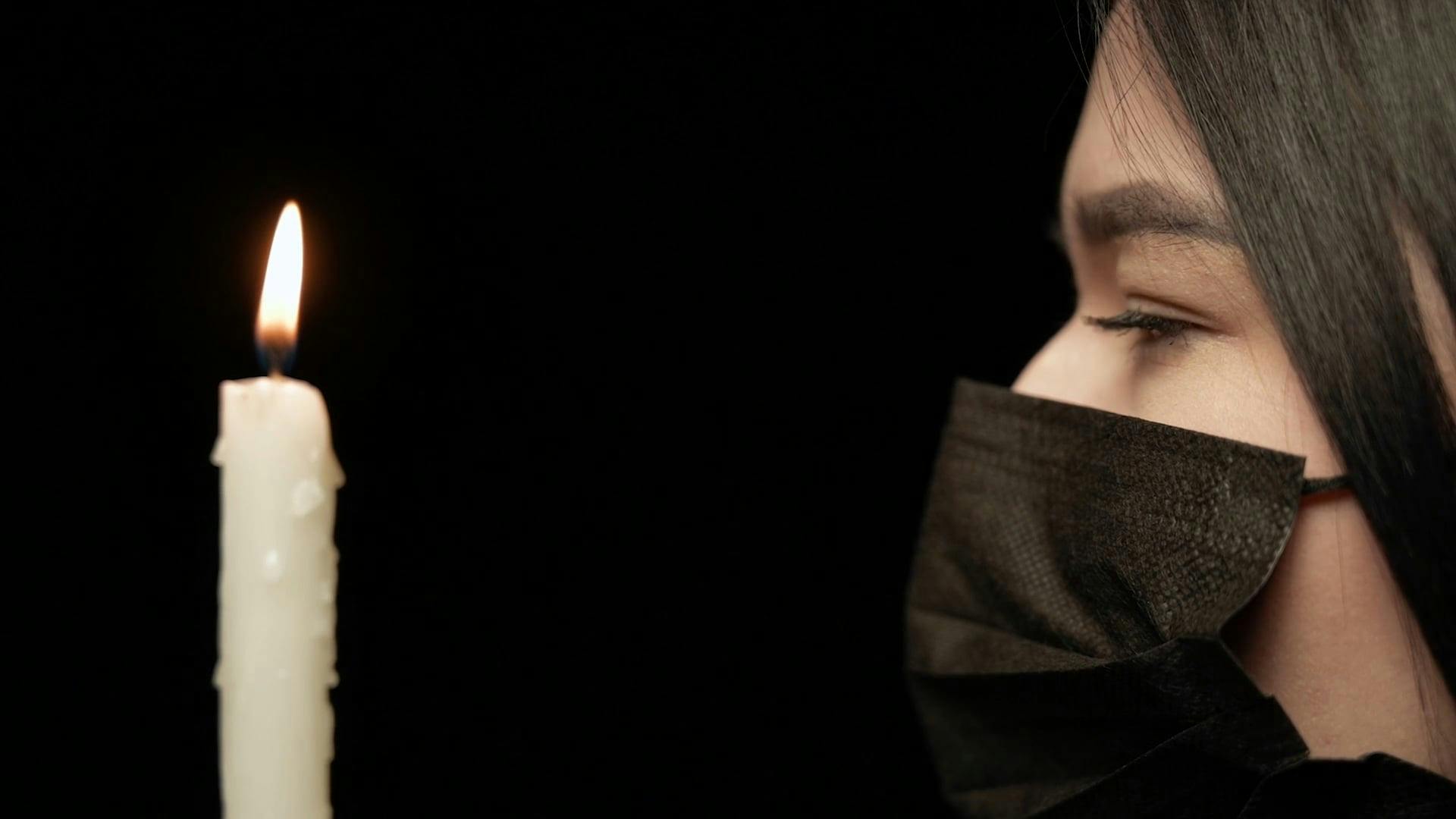 A Woman Blowing a Candle while Wearing a Face Mask Free Stock Video ...