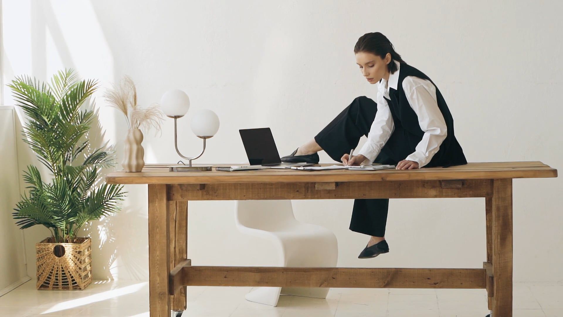 Woman Sitting on Top of Table · Free Stock Video