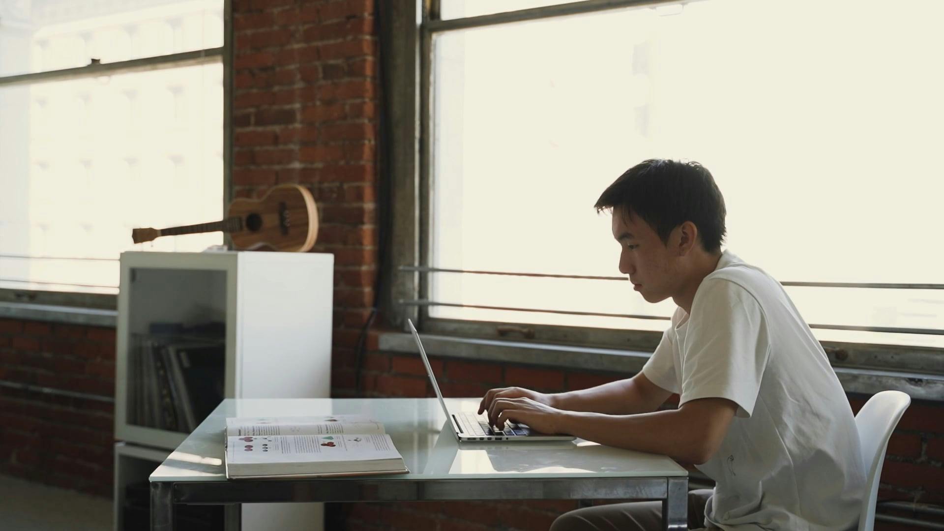 A Man Typing on a Laptop · Free Stock Video