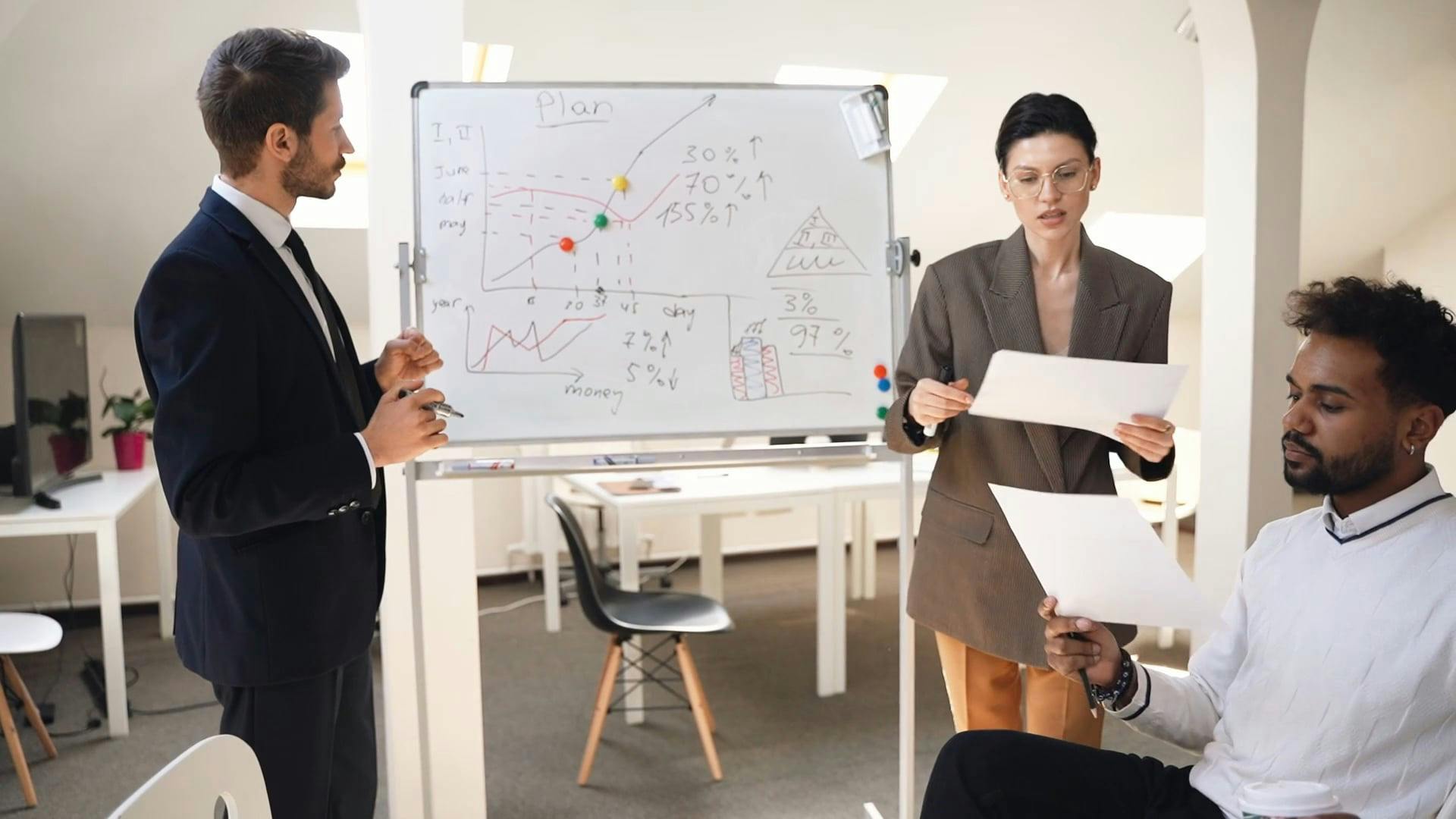 A Woman Looking At Charts On A Smart Pad In A Business Meeting Free ...