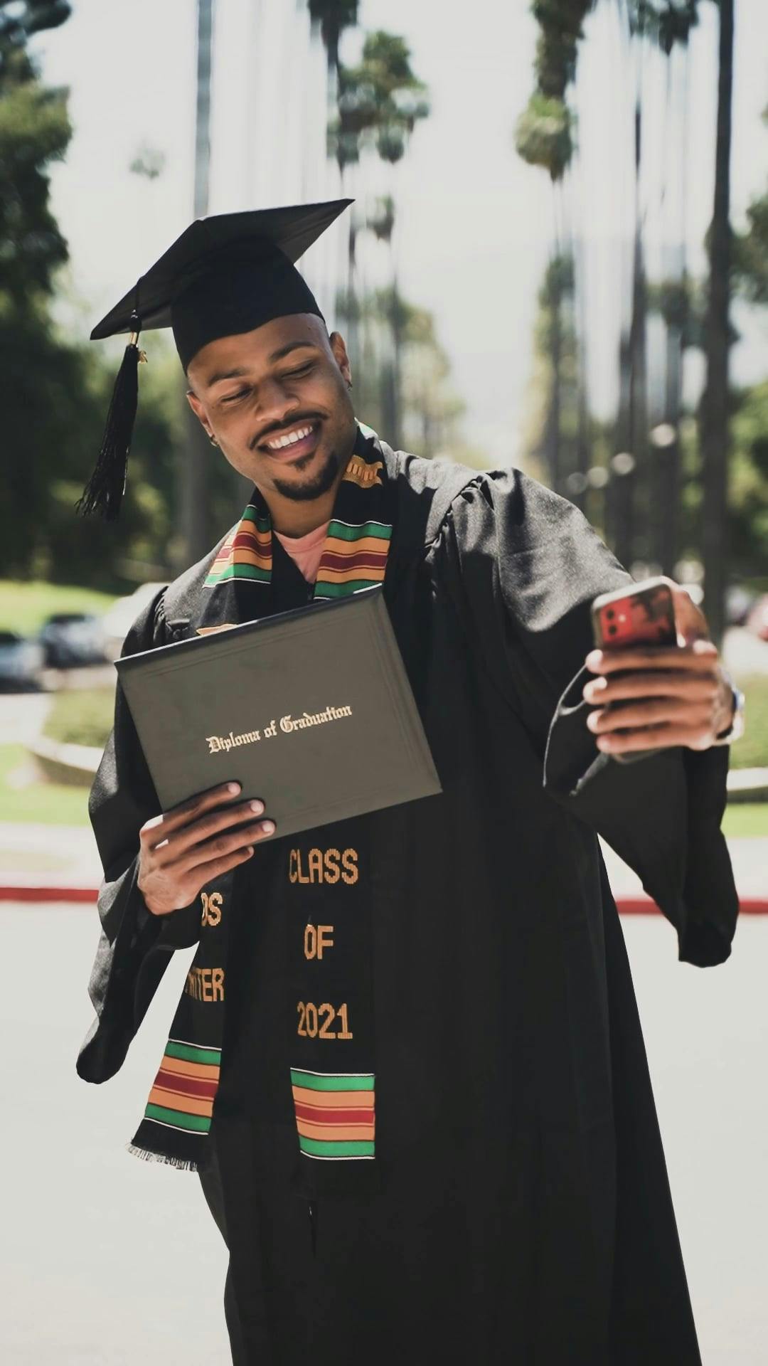 A Woman Spinning and Smiling While Removing Her Graduation Cap Free ...