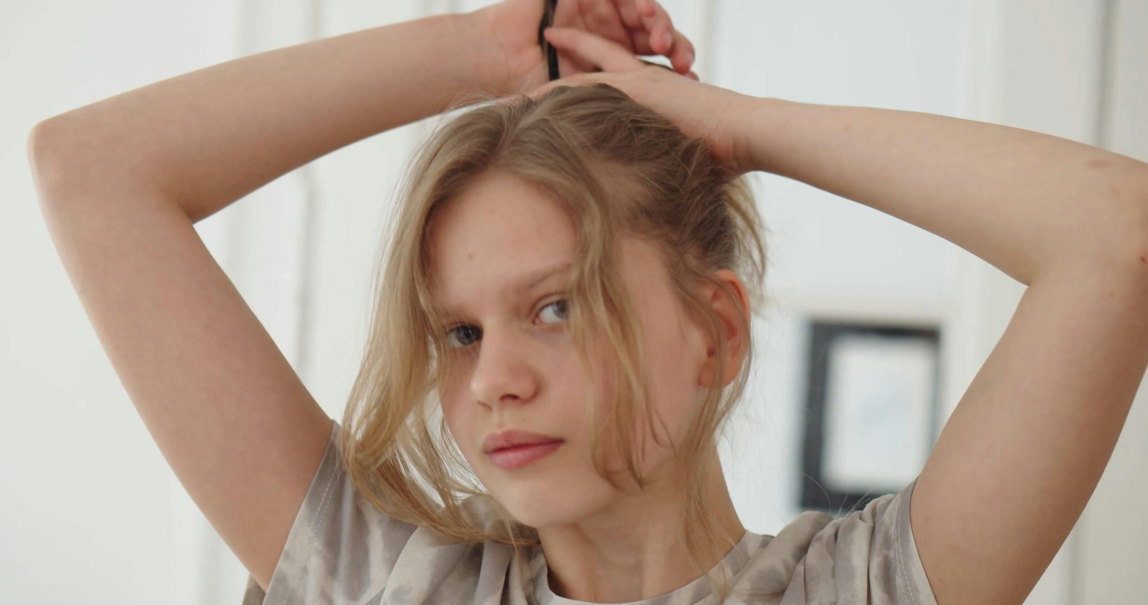 A Girl Tying Her Hair · Free Stock Video