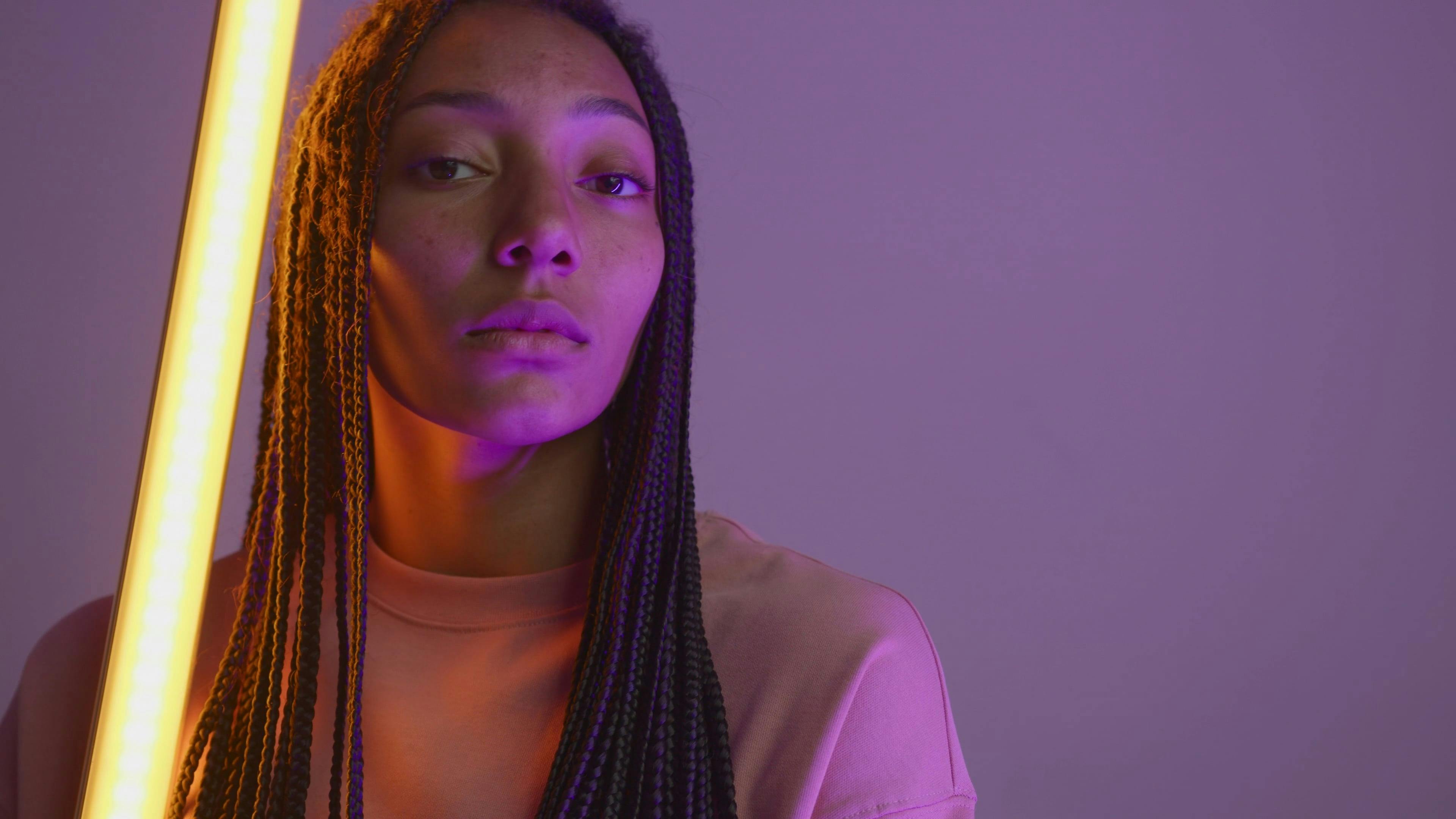 A Young Woman Posing with a Neon Light · Free Stock Video