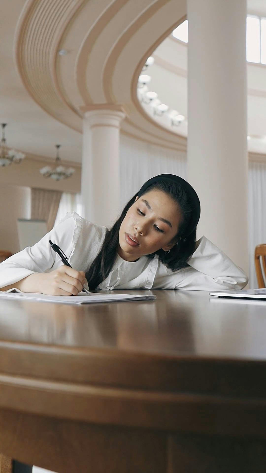 Woman Writing on a Paper · Free Stock Video