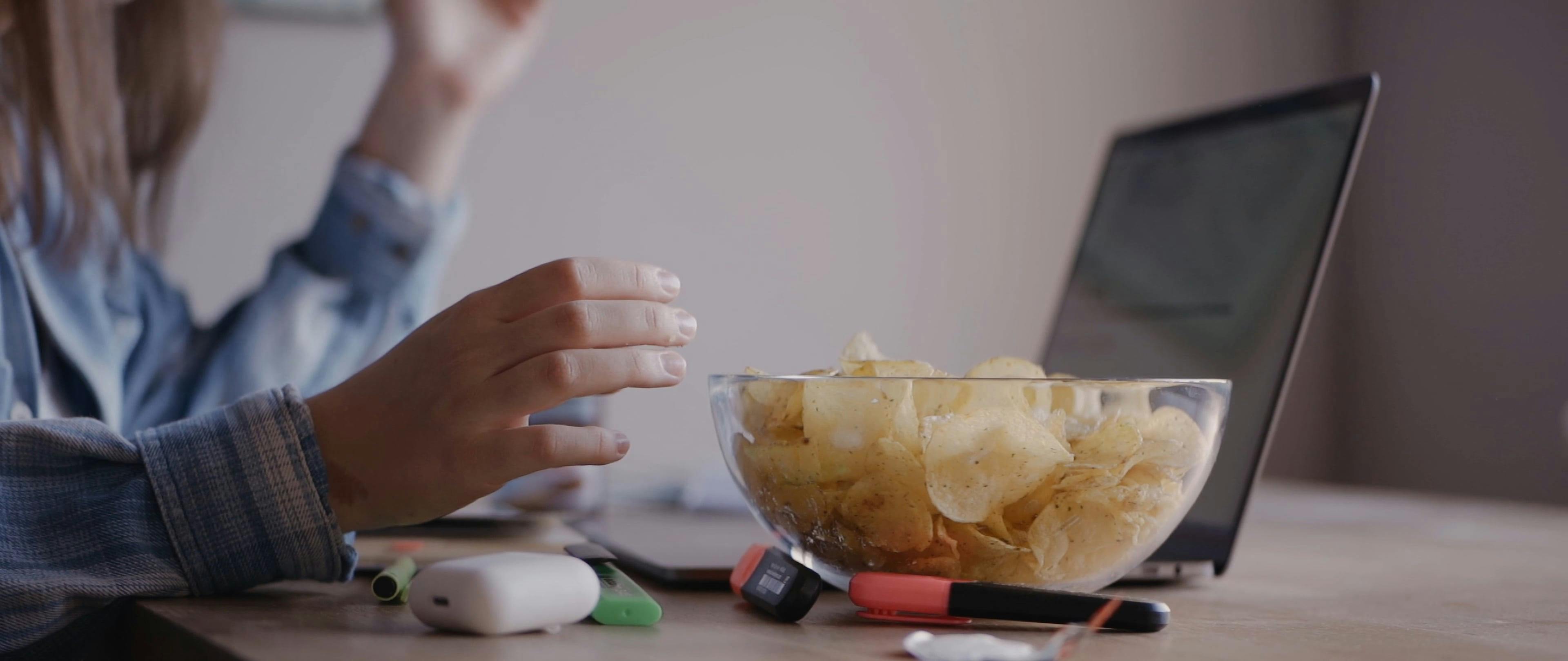 Person Eating Chips in front of a Laptop Free Stock Video Footage ...