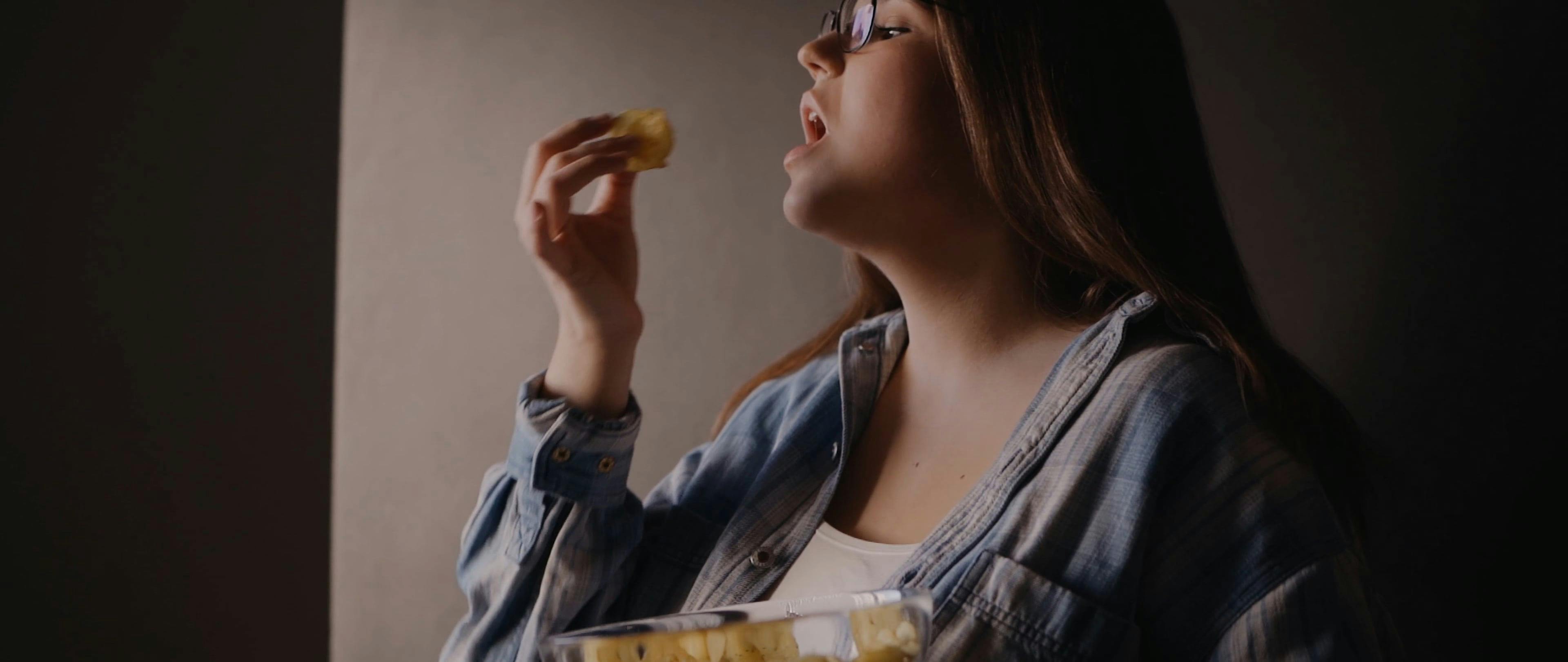 Woman Eating Chips while Working at Home · Free Stock Video