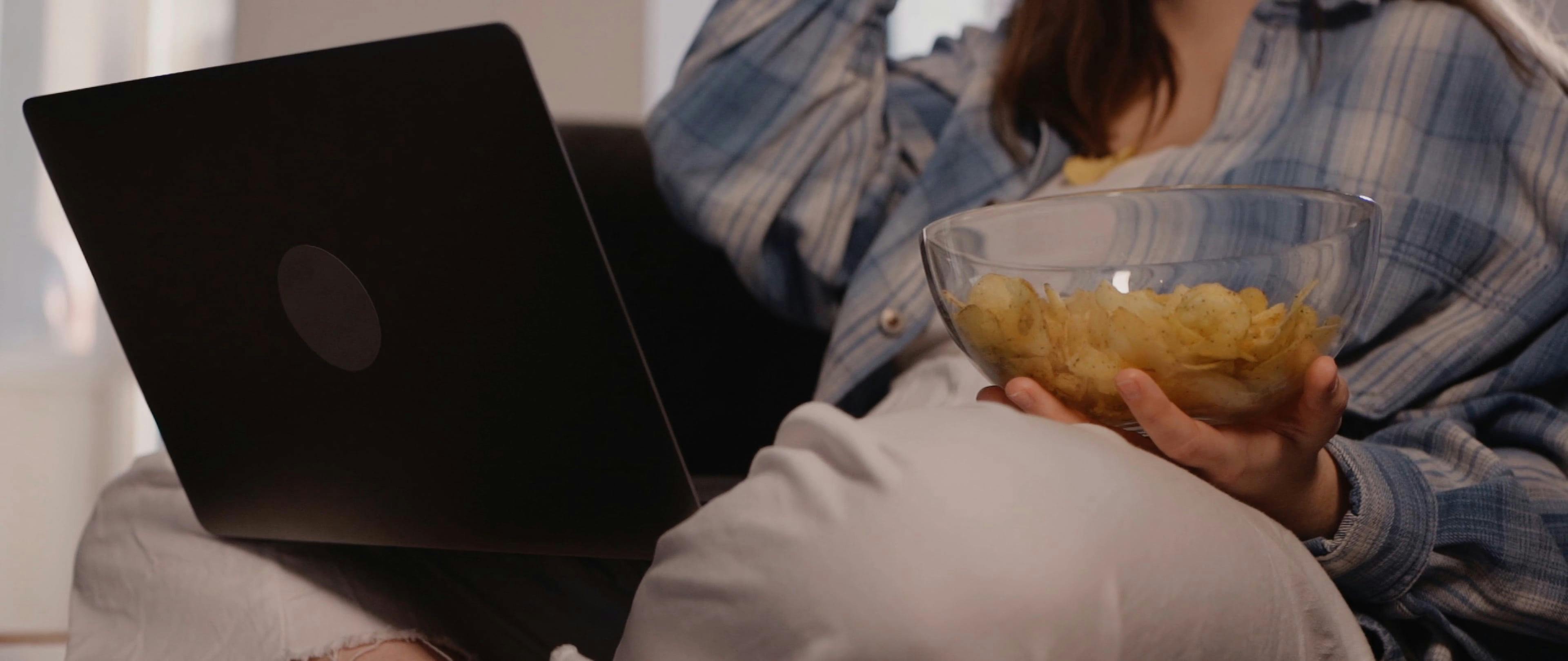 A Person Eating Chips while Using a Laptop Free Stock Video Footage ...