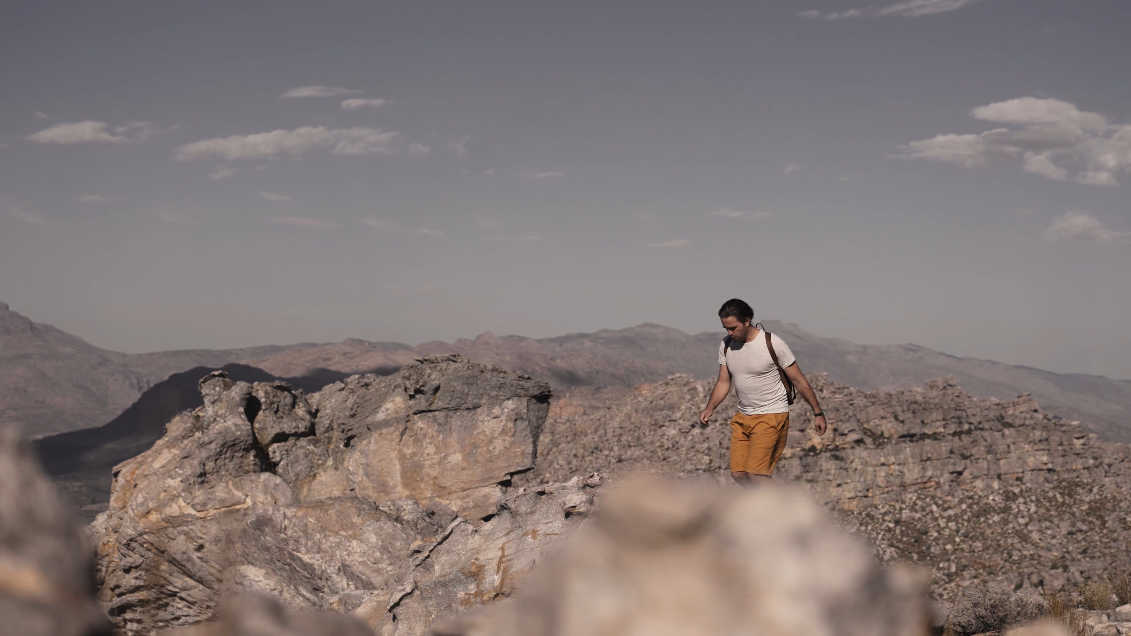 A Man Standing on Rocks Feeling Excited · Free Stock Video