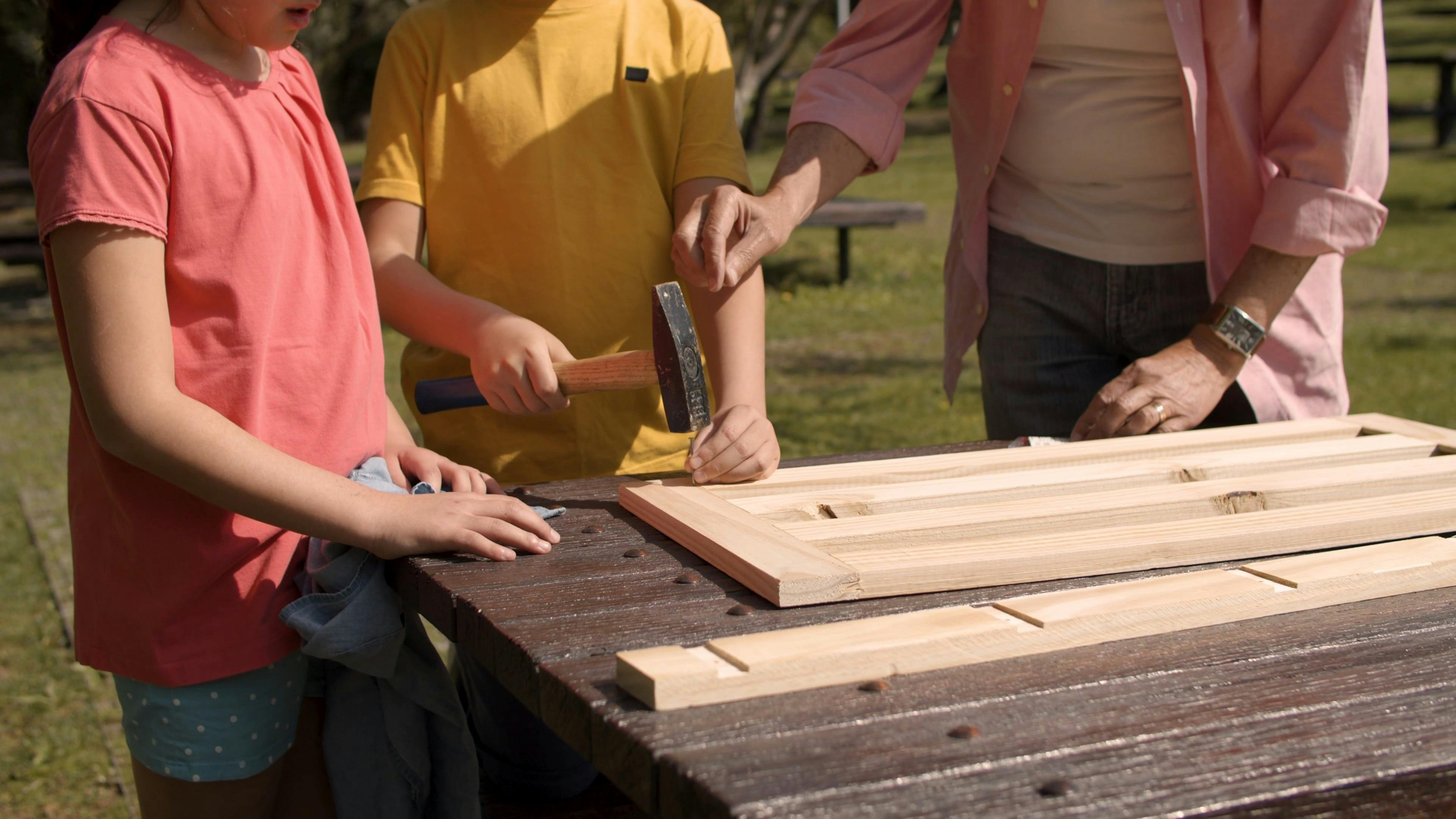 Two Children Learning Carpentry with their Grandfather Free Stock Video ...