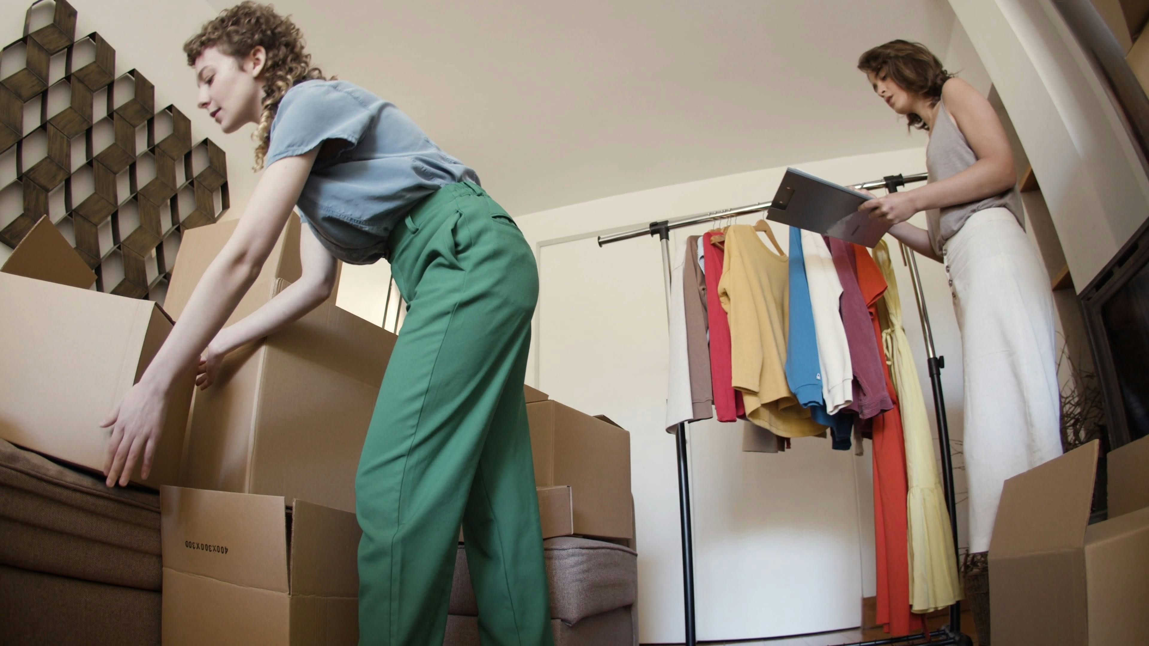 Two Women Fixing Boxes · Free Stock Video