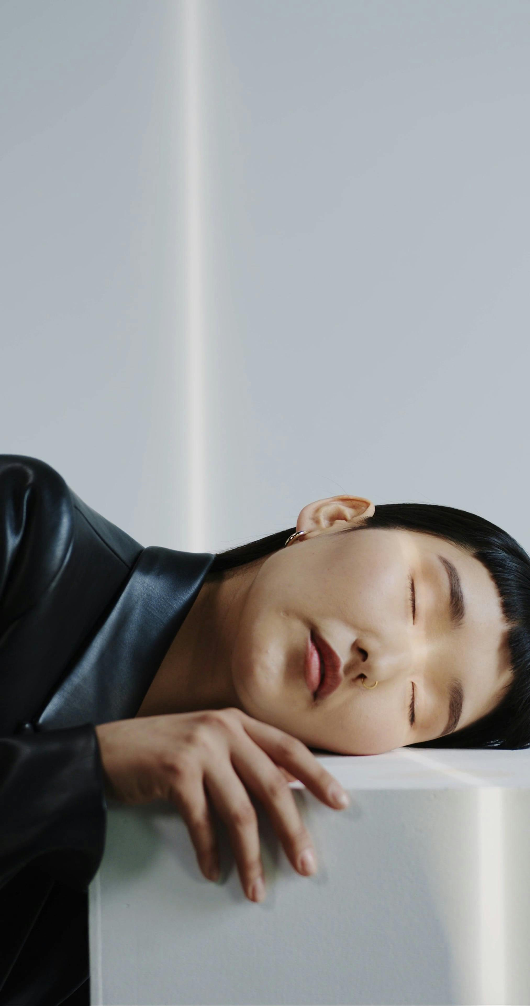 Female Model Laying Head on White Cube Free Stock Video Footage ...