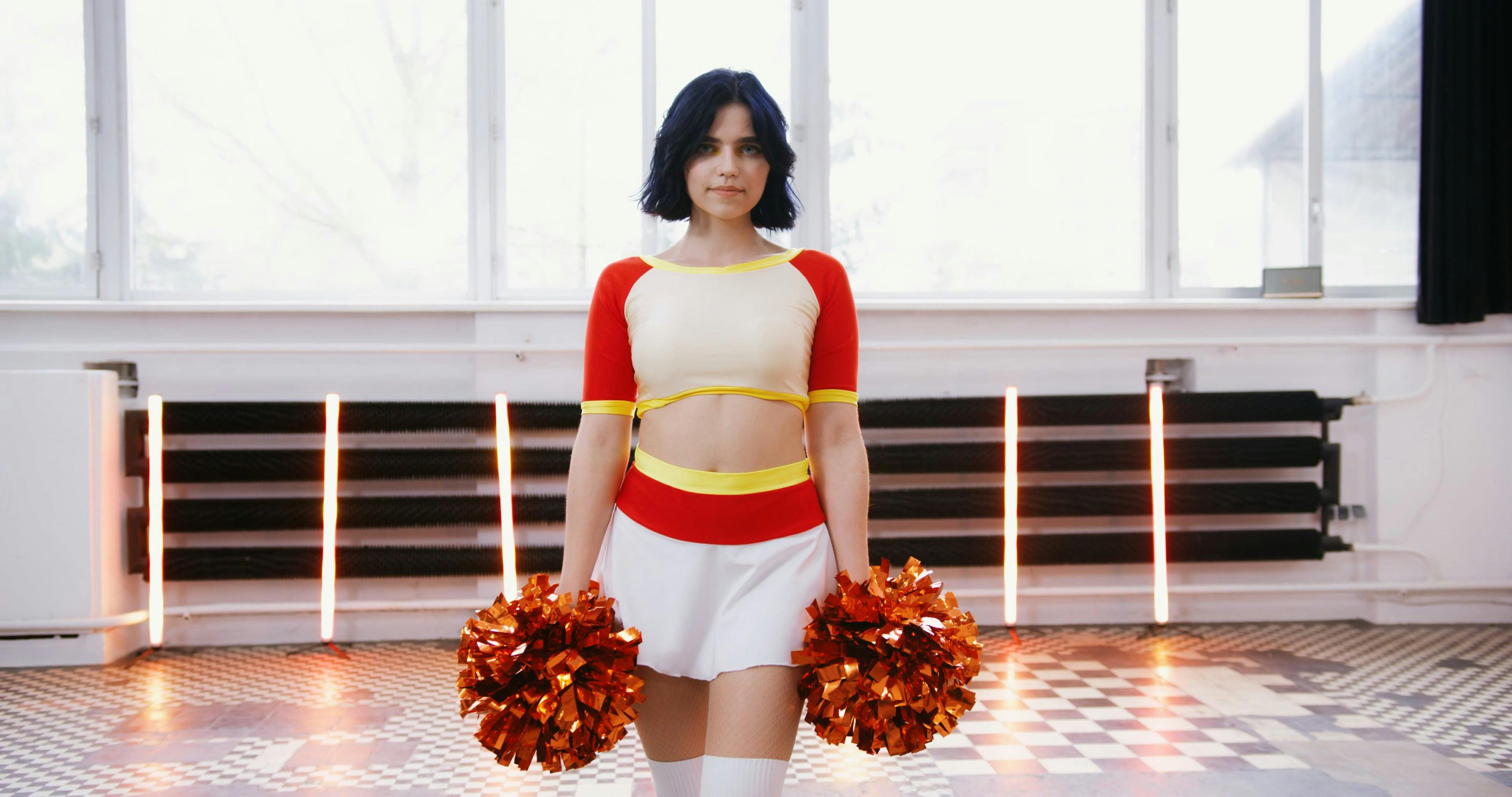 A Cheerleader Holding Pompoms · Free Stock Video