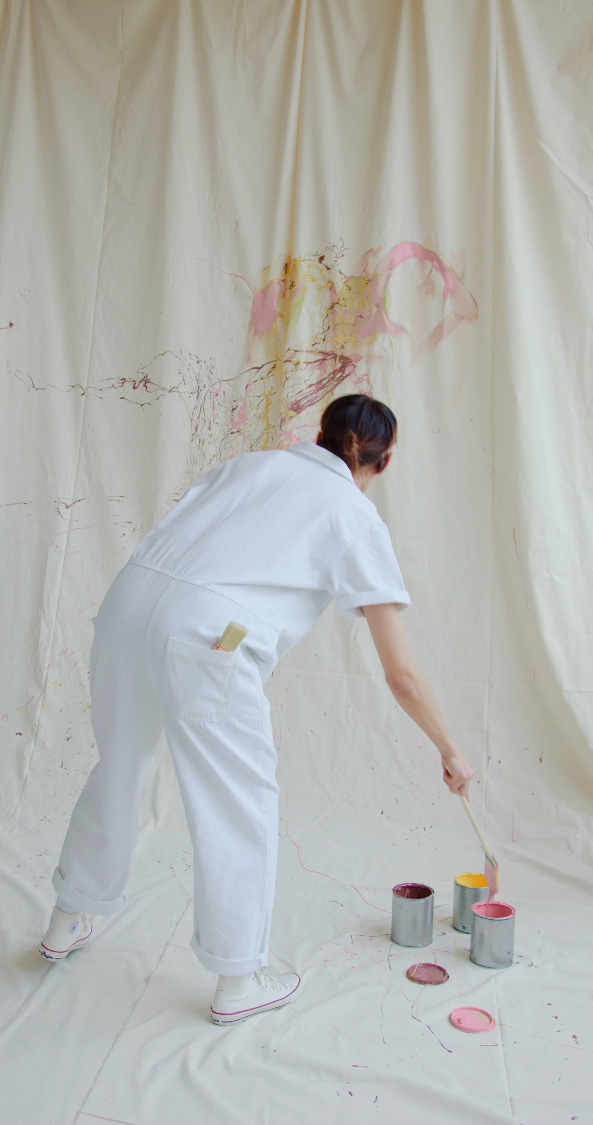 Backview of a Man Splattering Paint on a Canvas · Free Stock Video
