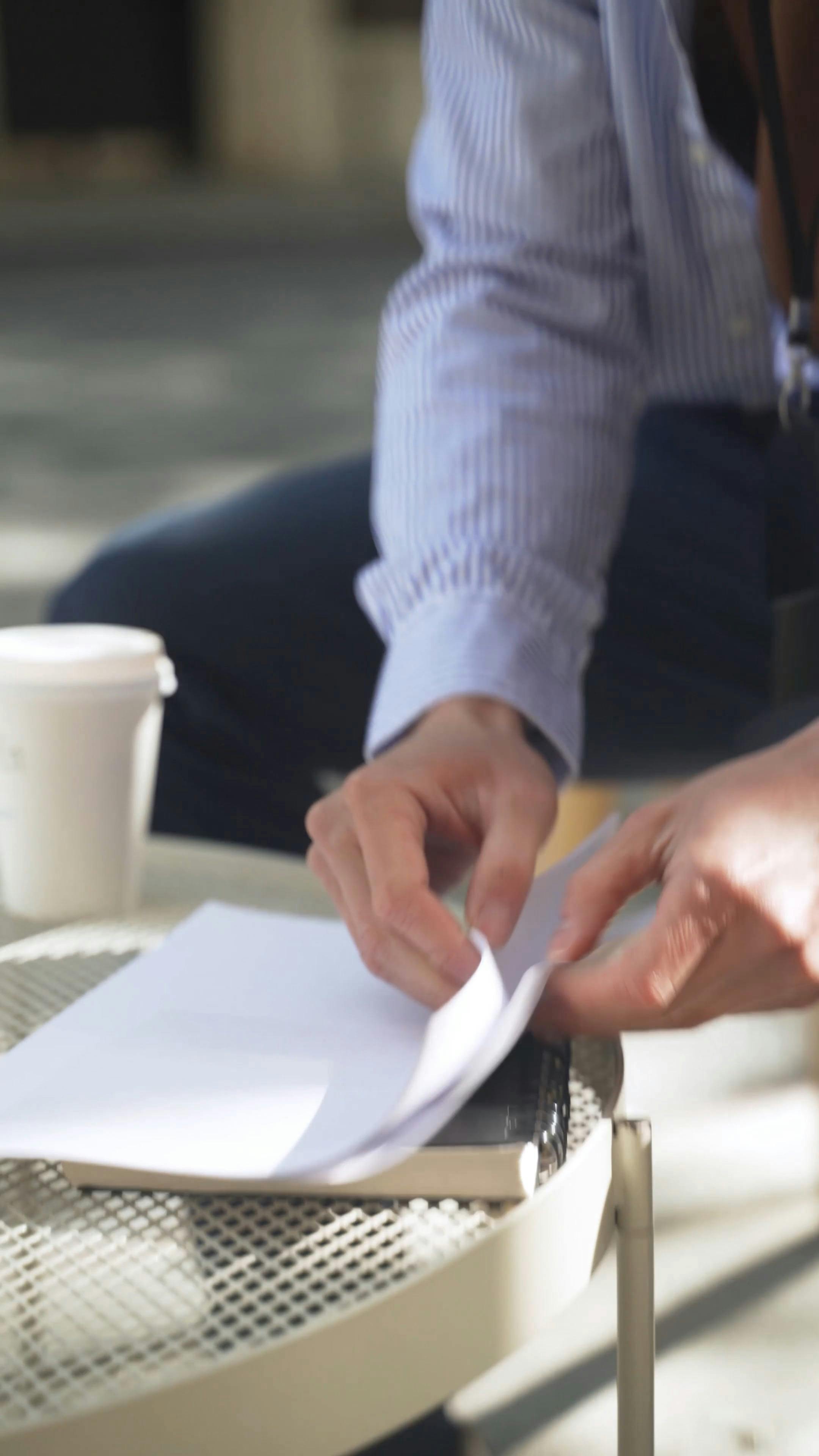 A Person Holding and Pointing at Documents · Free Stock Video