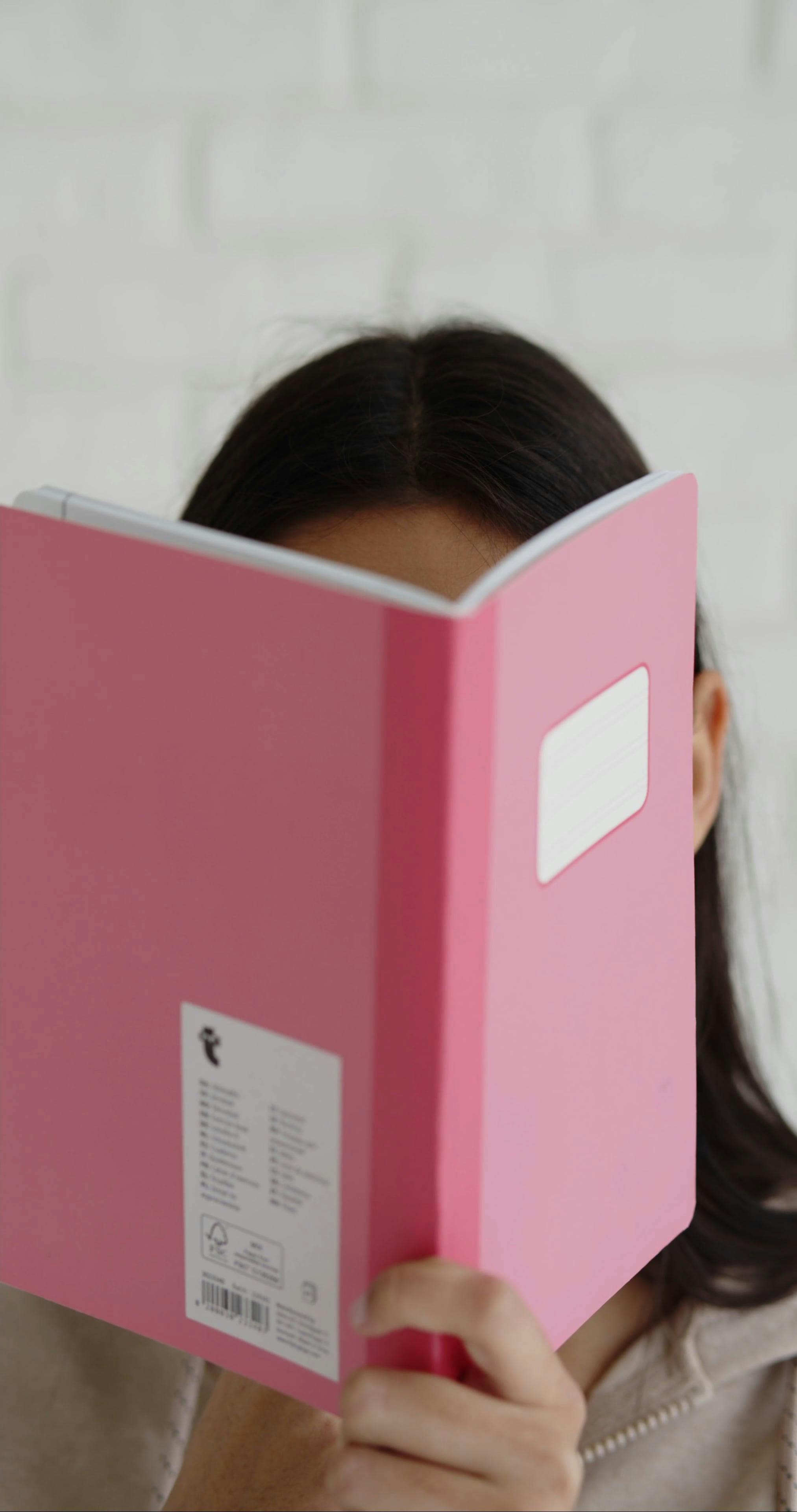 Woman Covering Her Face With a Notebook · Free Stock Video