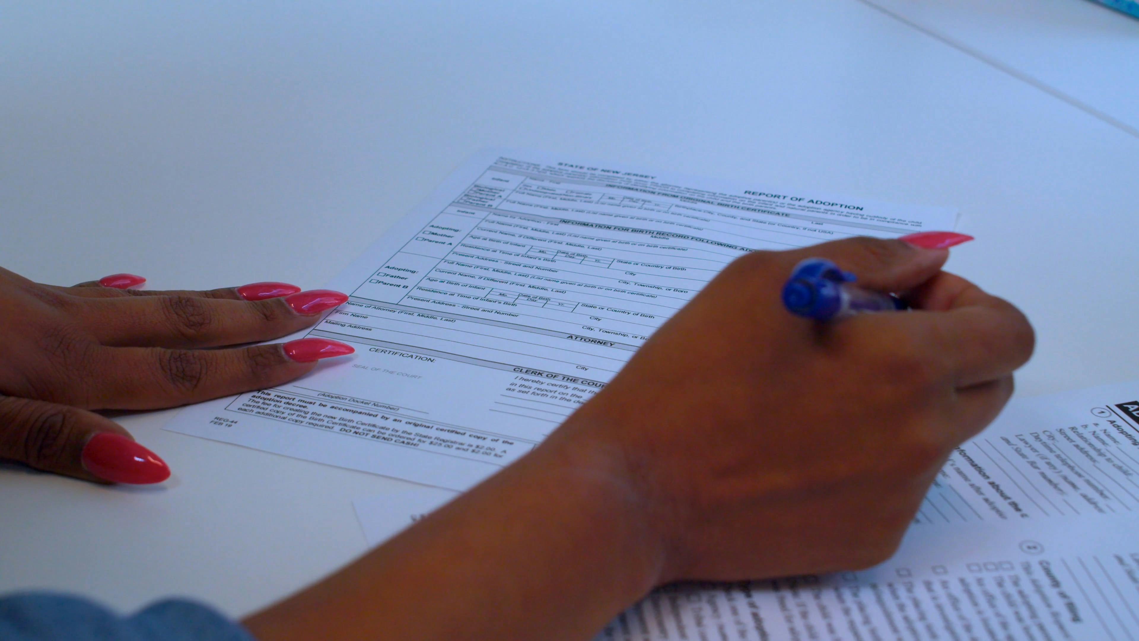 Person Signing Paper Forms · Free Stock Video