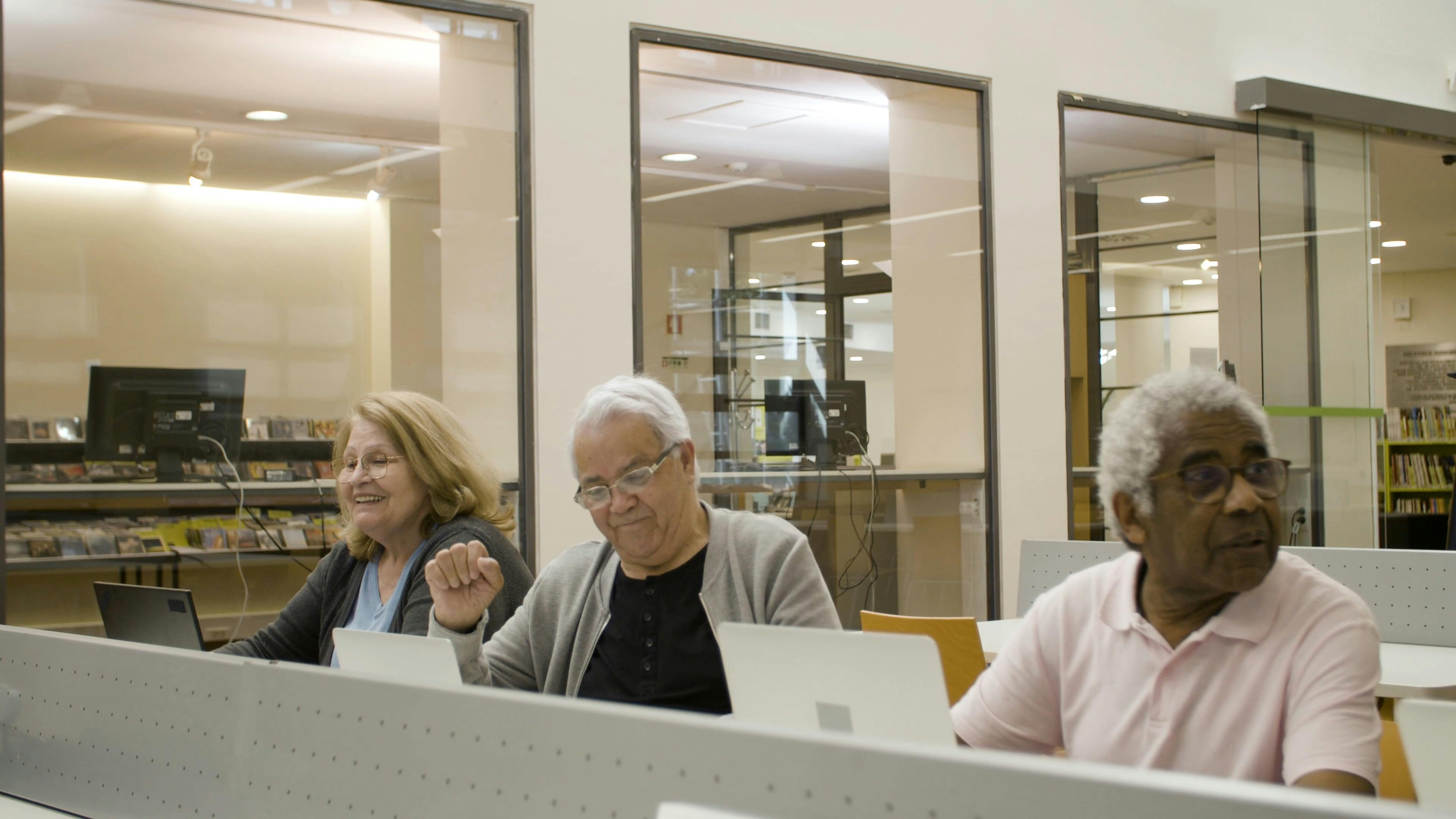 An Instructor Teaching Elderly People how to Use Laptops · Free Stock Video