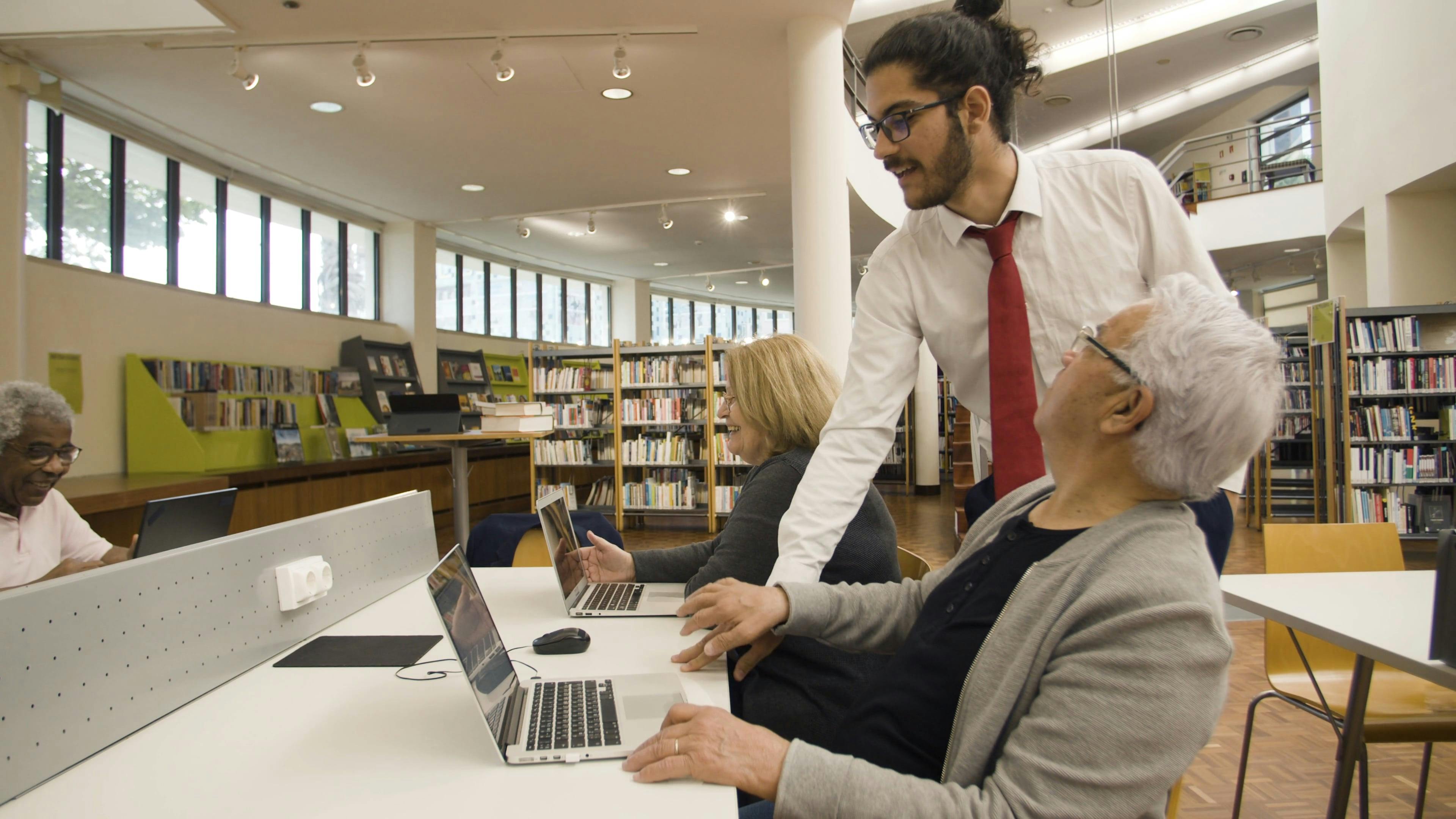 A Man teaching Elderly People How to Use Computers Free Stock Video ...