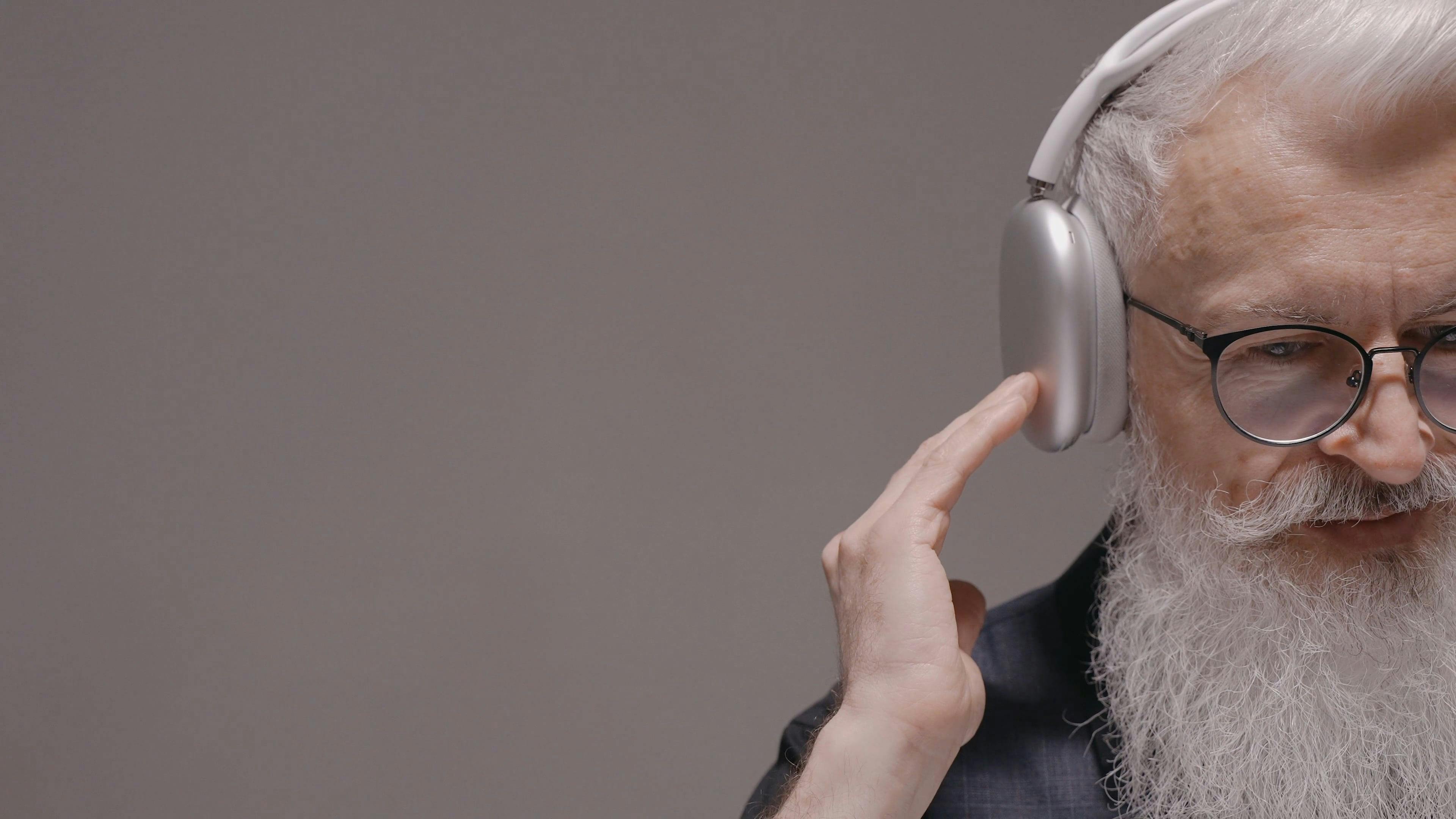 A Close Up of an Elderly Man Wearing Wireless Headphones · Free Stock Video