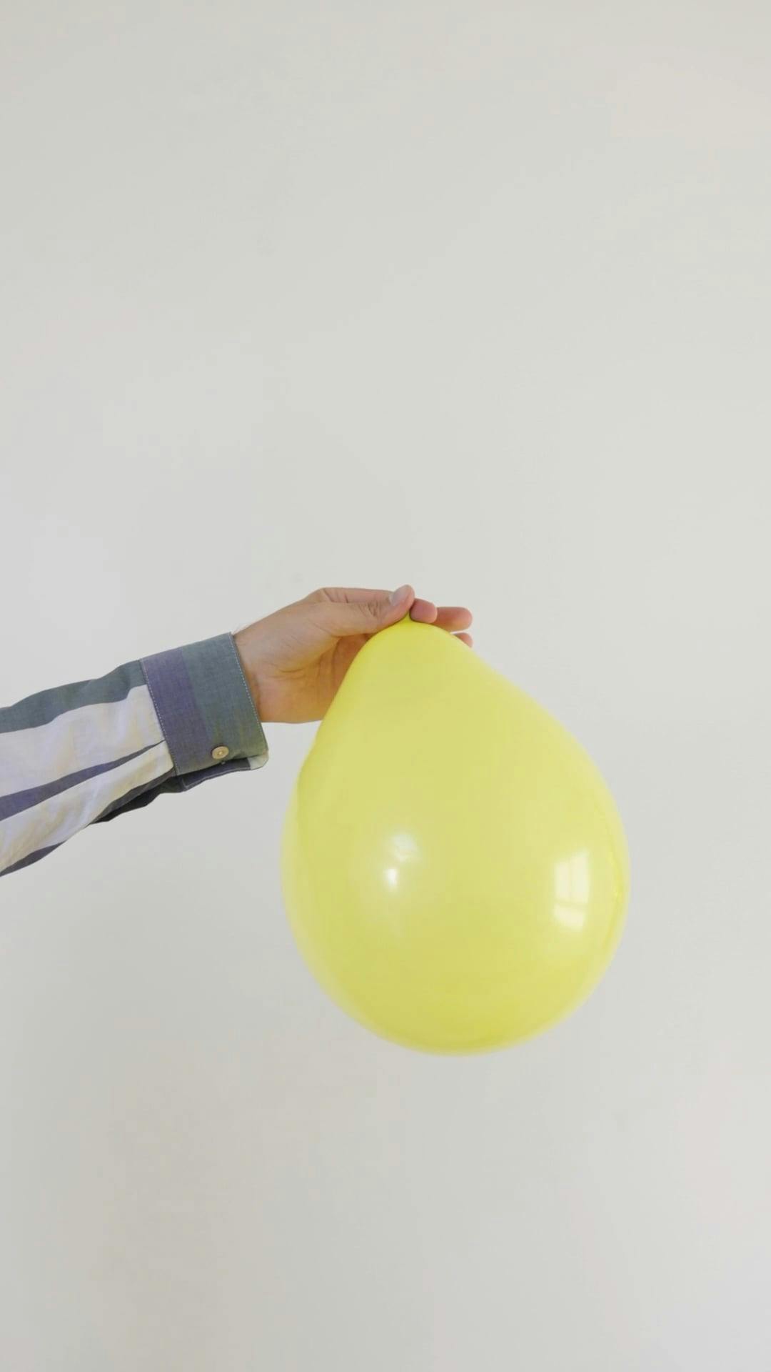 A Person Holding a Yellow Balloon Then Letting it Go Free Stock Video ...