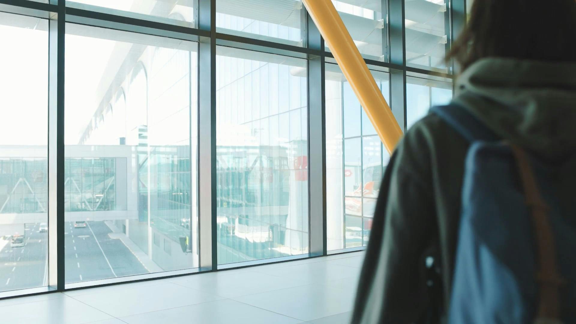 A Woman Walking to the Window at an Airport Free Stock Video Footage ...