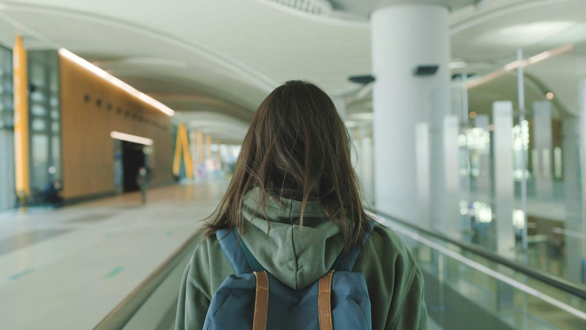Woman Standing On A Walkalator Inside An Airport · Free Stock Video