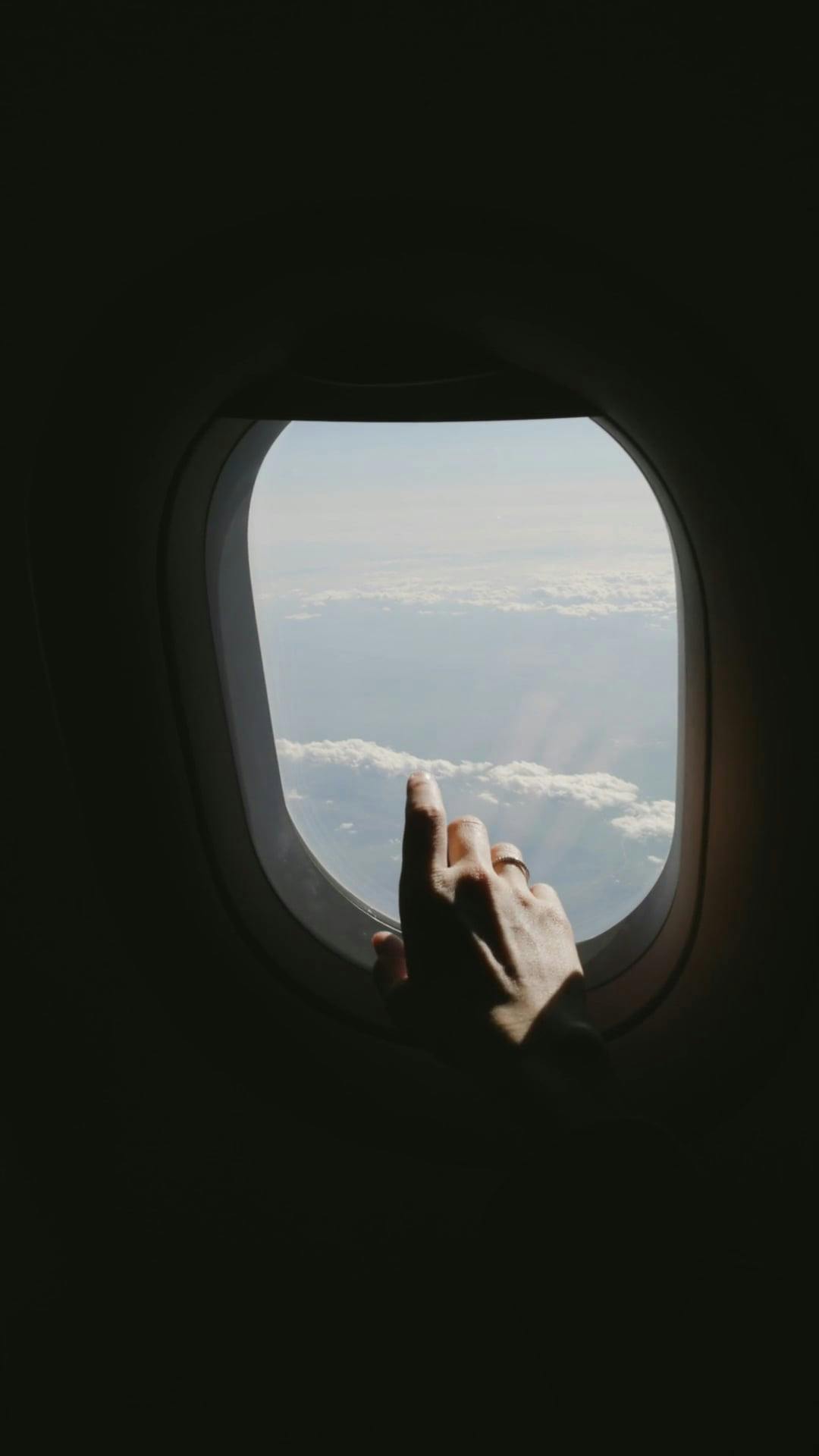 A Person Touching the Window in the Airplane · Free Stock Video