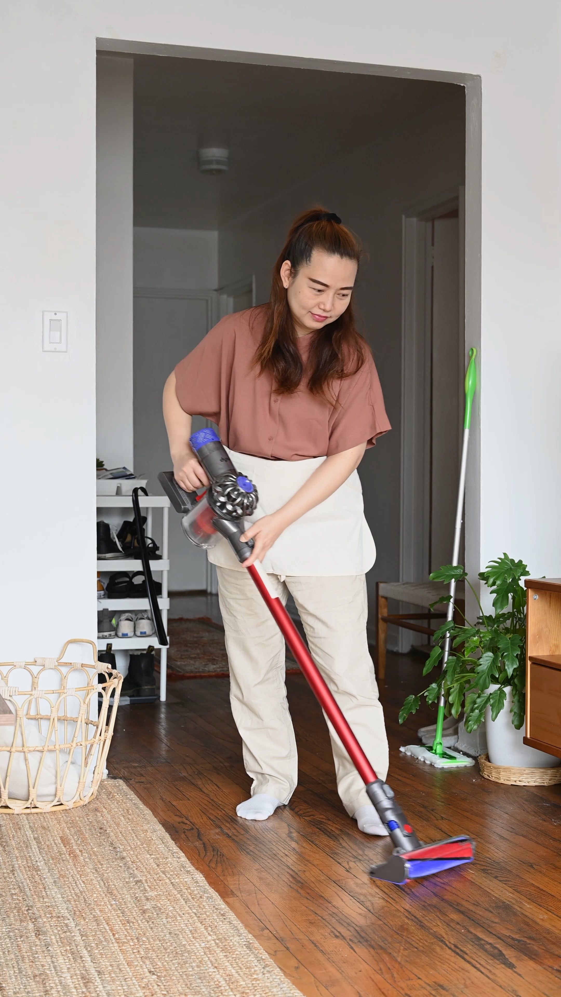 A Woman Using a Vacuum Cleaner · Free Stock Video