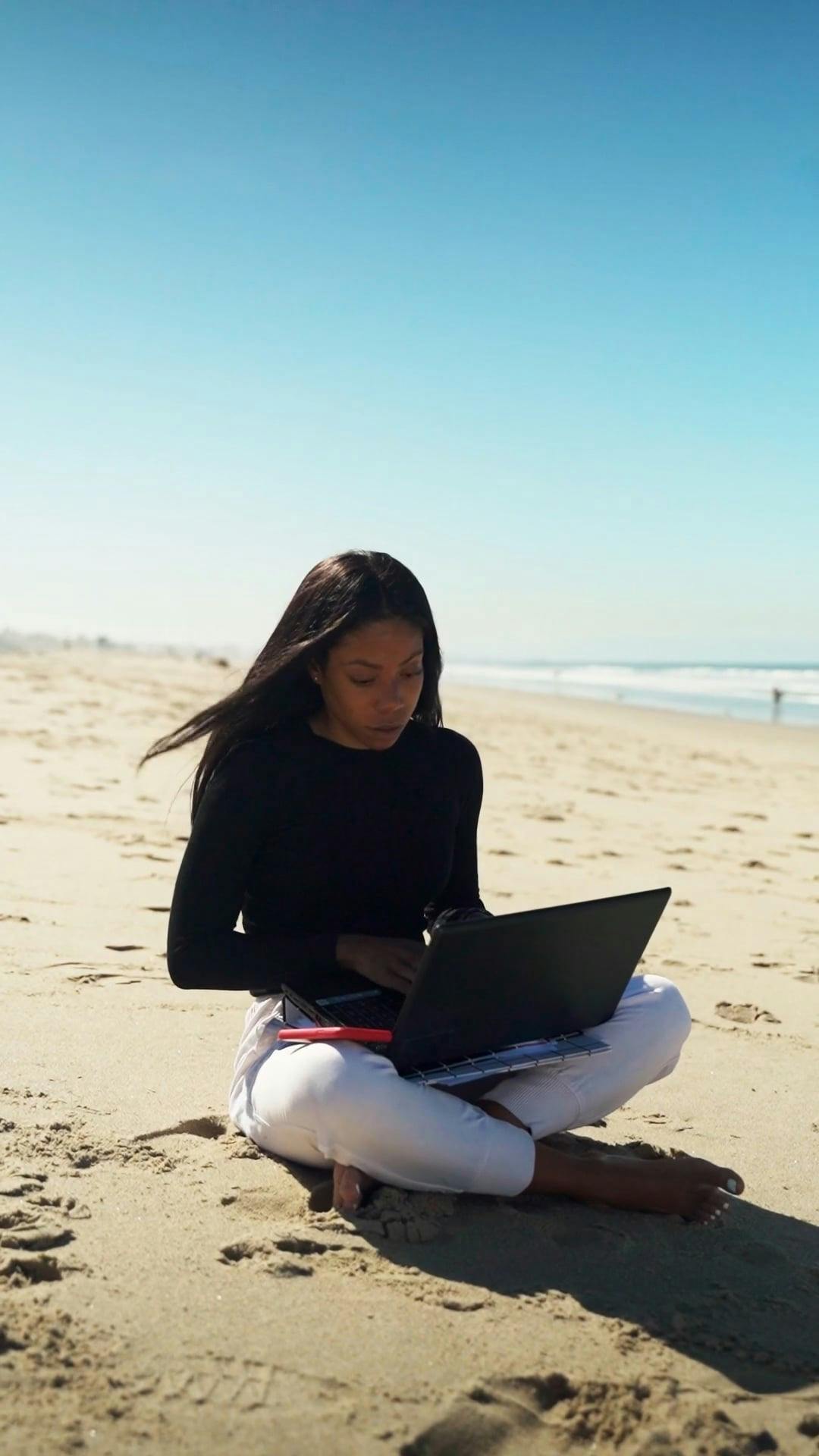 Woman using Smartphone While Holding Laptop · Free Stock Video