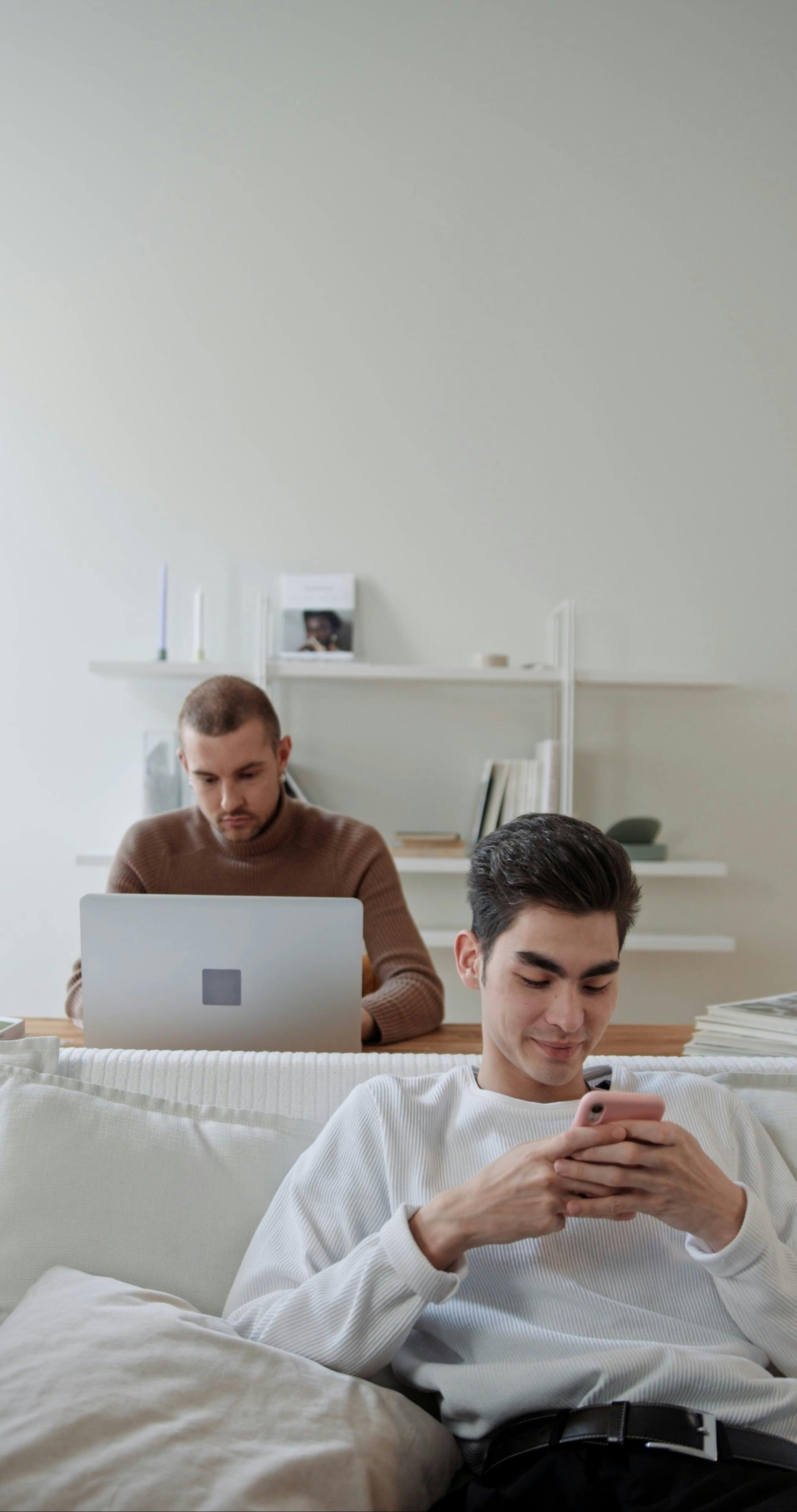A Jealous Man Looking at His Partner Smiling while Using Mobile Phone ...