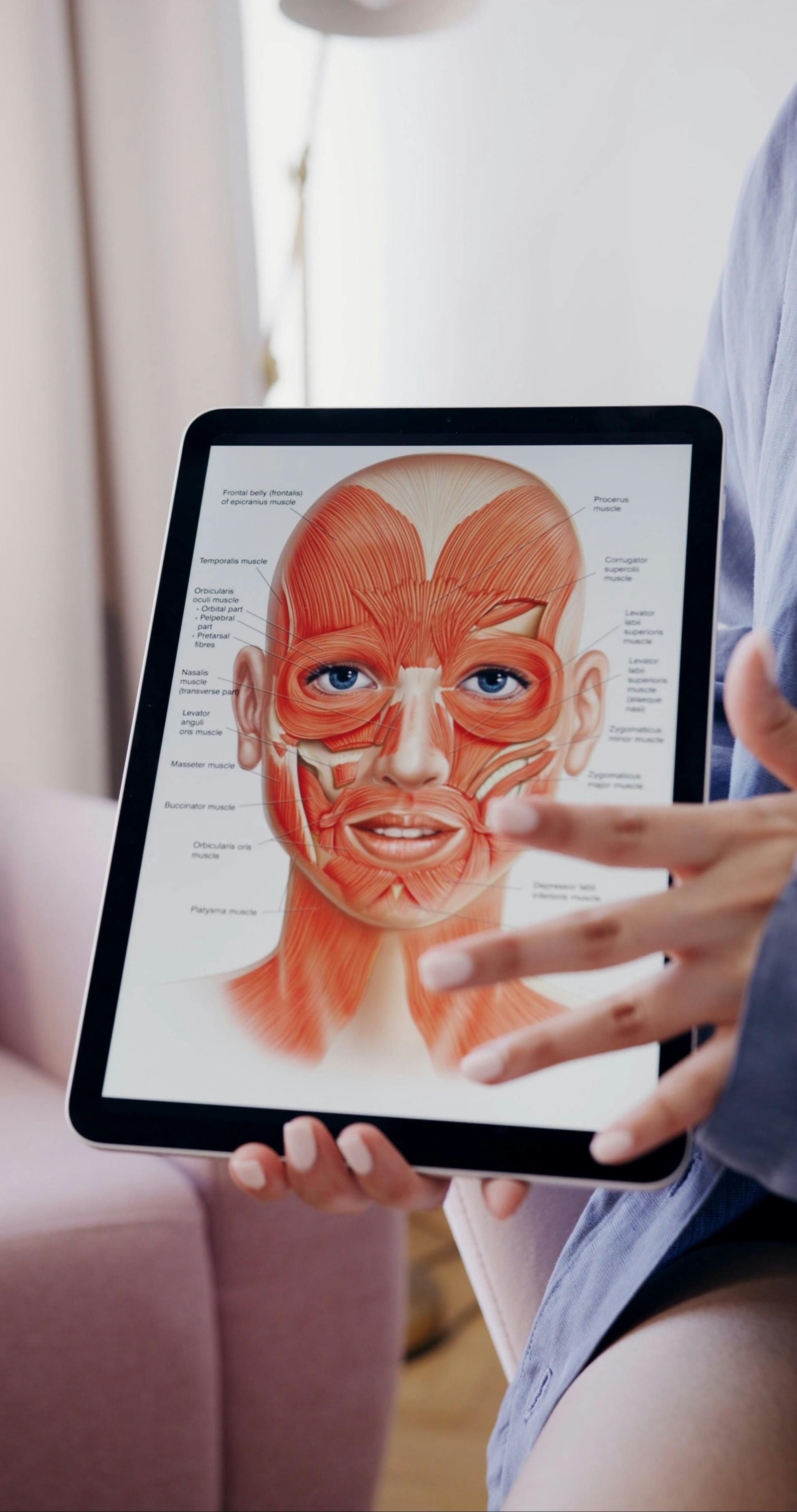 A Person Holding a Tablet Showing Face Muscles Picture Free Stock Video ...
